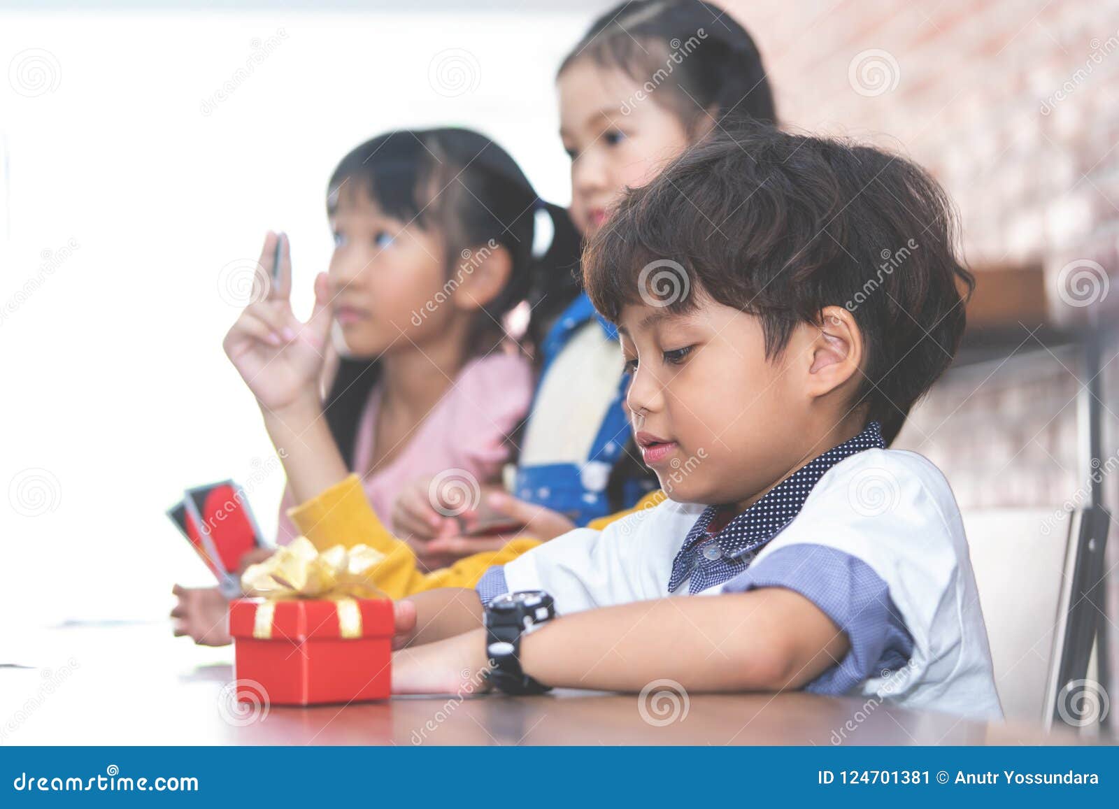 Little Boy with a Red Box of Present in Classroom Stock Image - Image ...