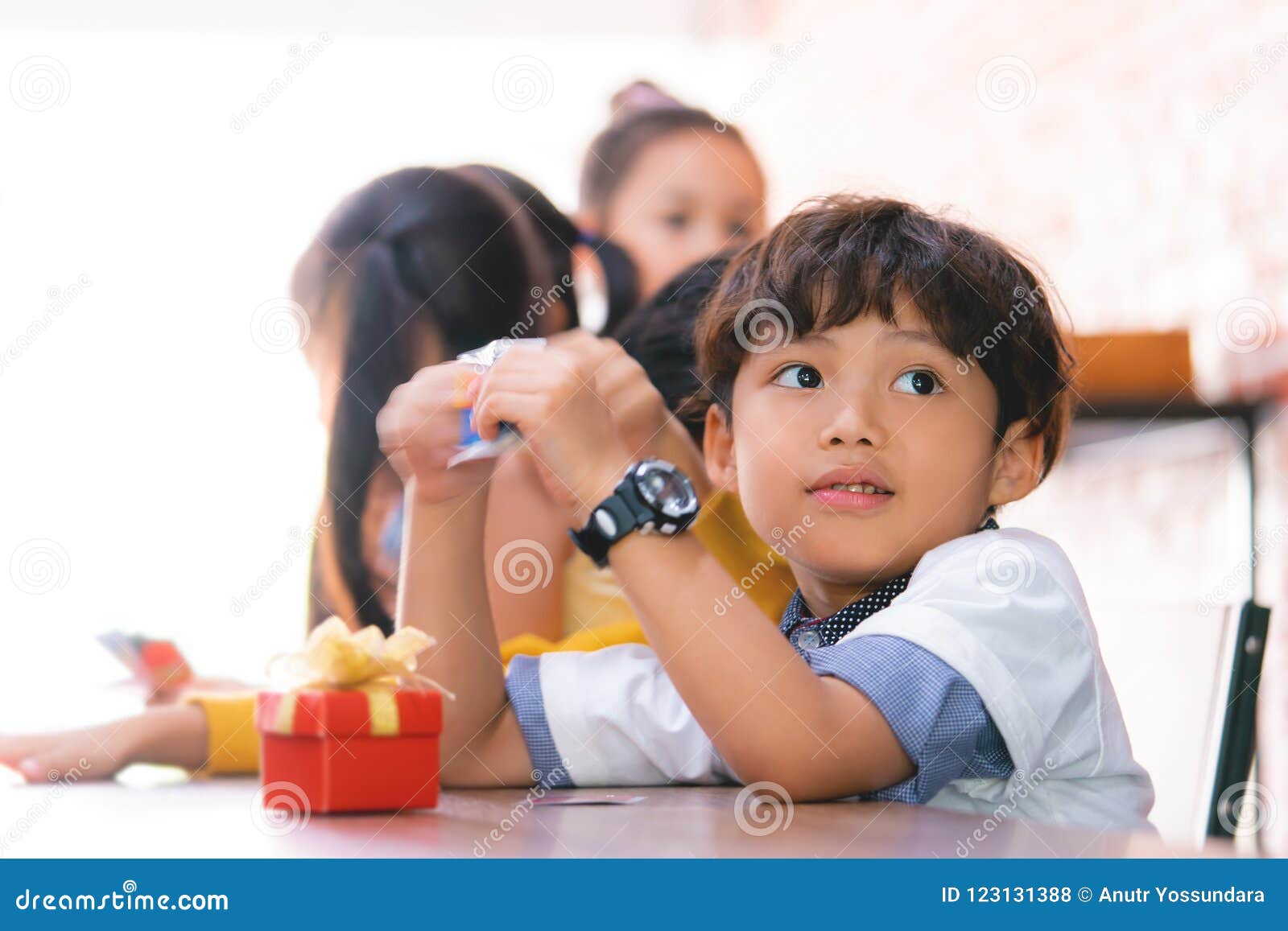 Little Boy with a Red Box of Present in Classroom Stock Photo - Image ...