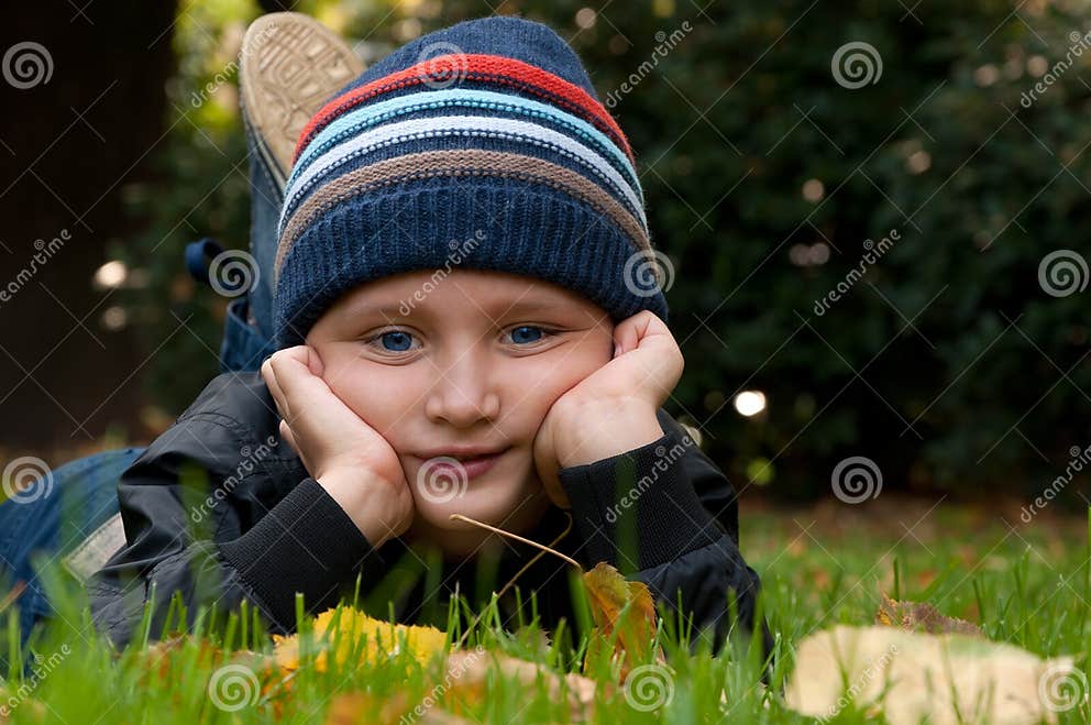 Little Boy Relaxing in the Park Stock Image - Image of nature, fall ...