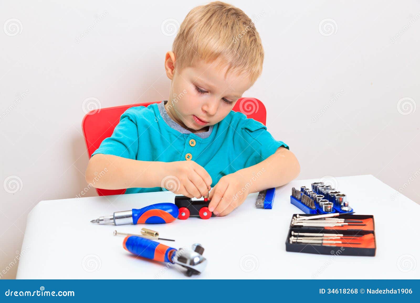 Little Boy Repairing Toy Train Stock Photo - Image of repairman ...