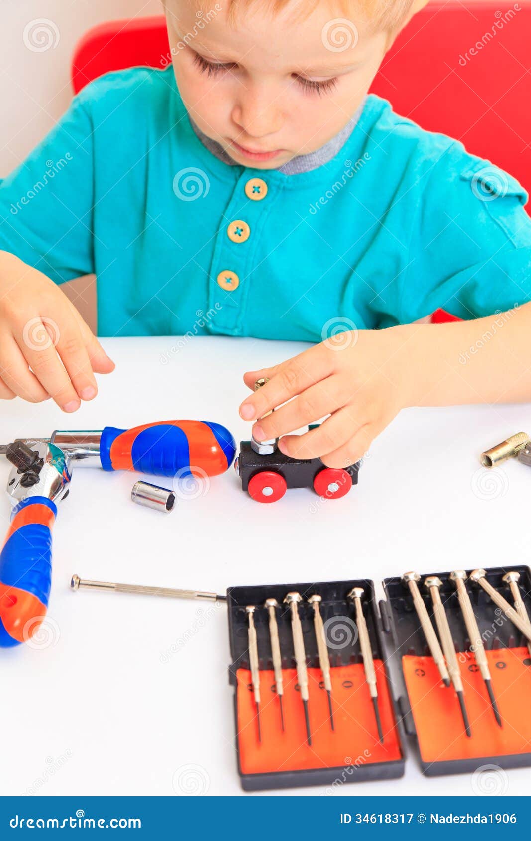 Little Boy Repairing Toy Train Stock Image - Image of playful, funny ...
