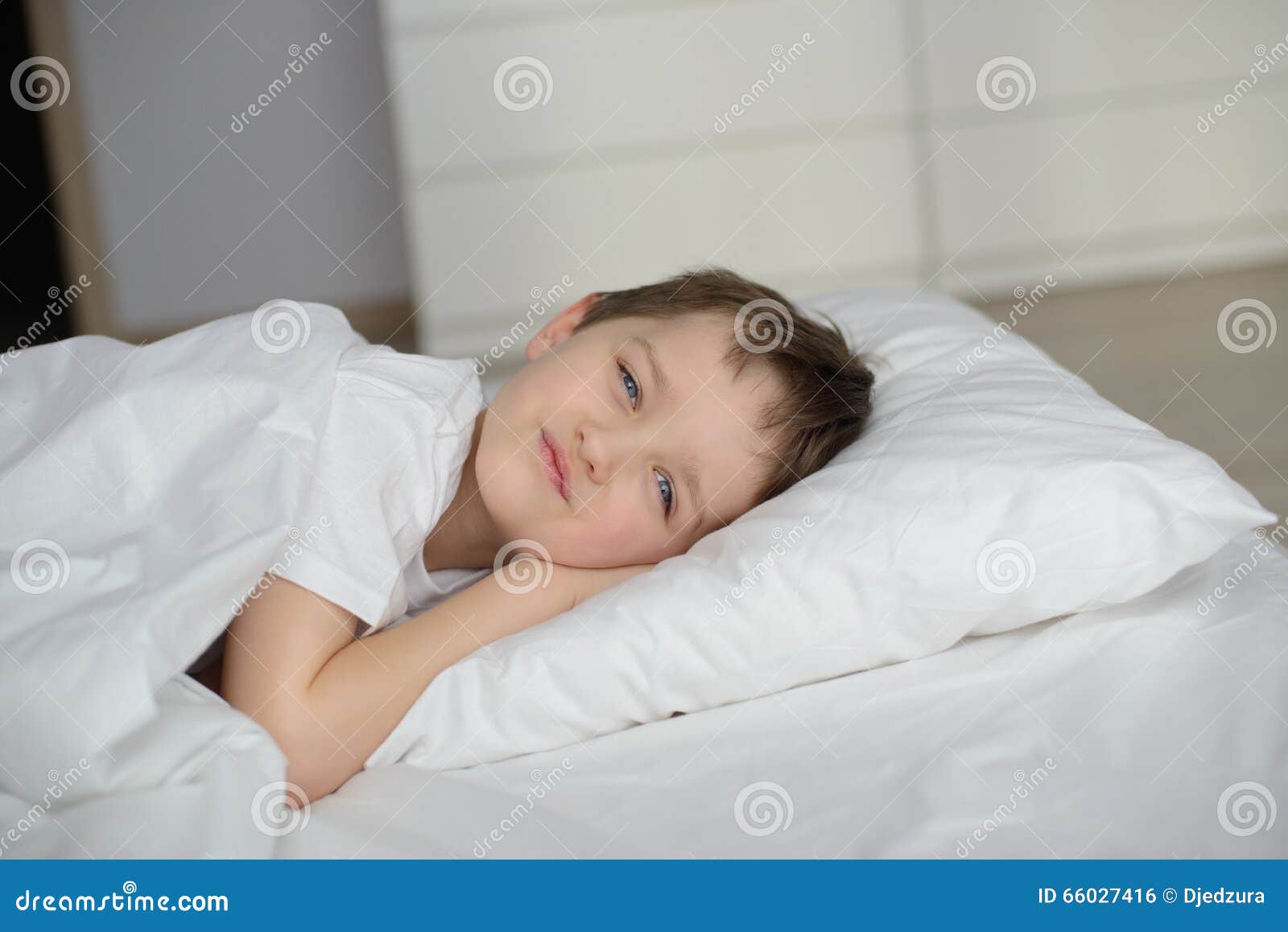 Little Boy Resting in White Bed with Eyes Open Stock Photo - Image of ...