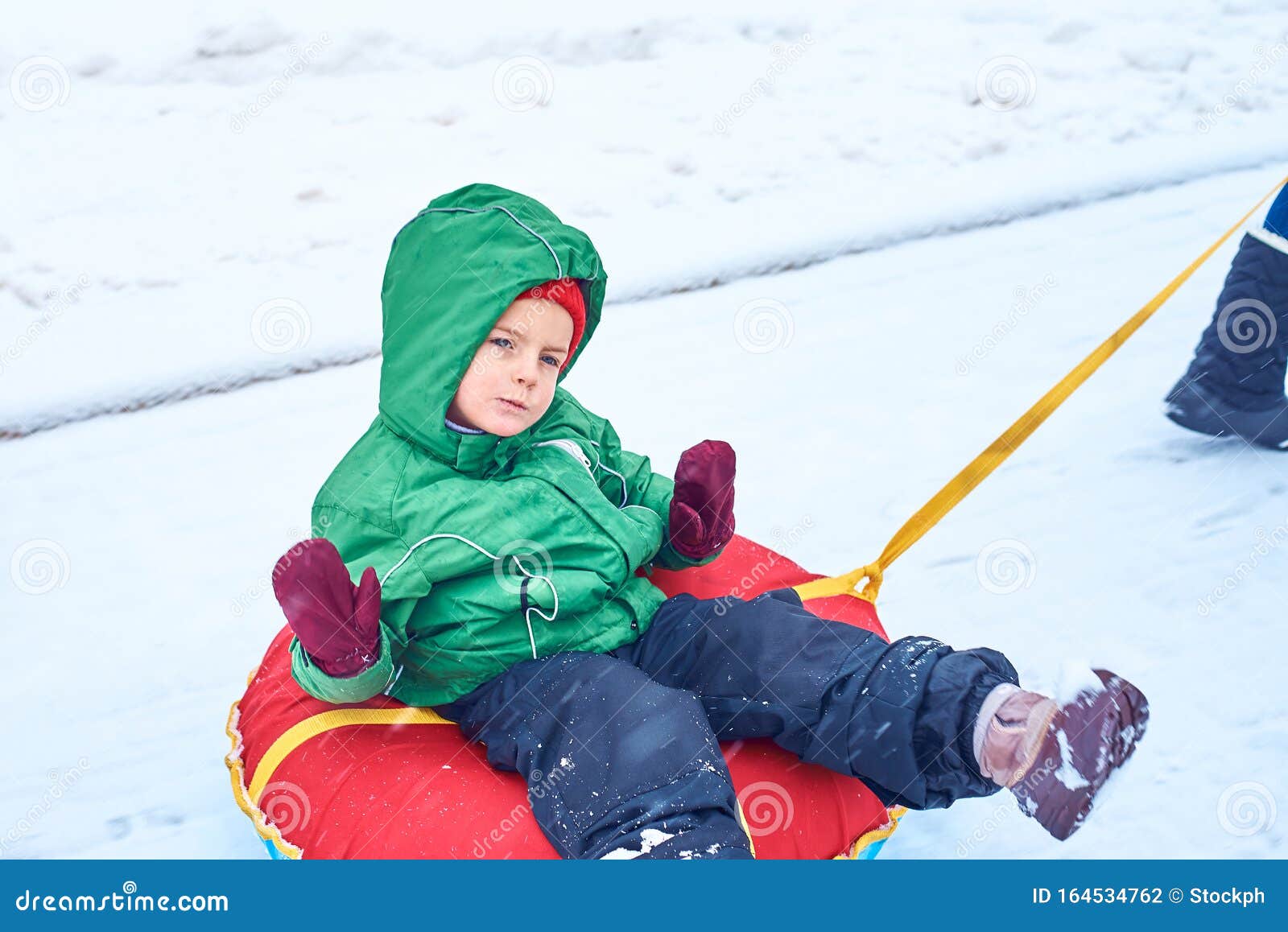 Little Boy Rides on a Sled in Winter. Stock Photo - Image of park ...