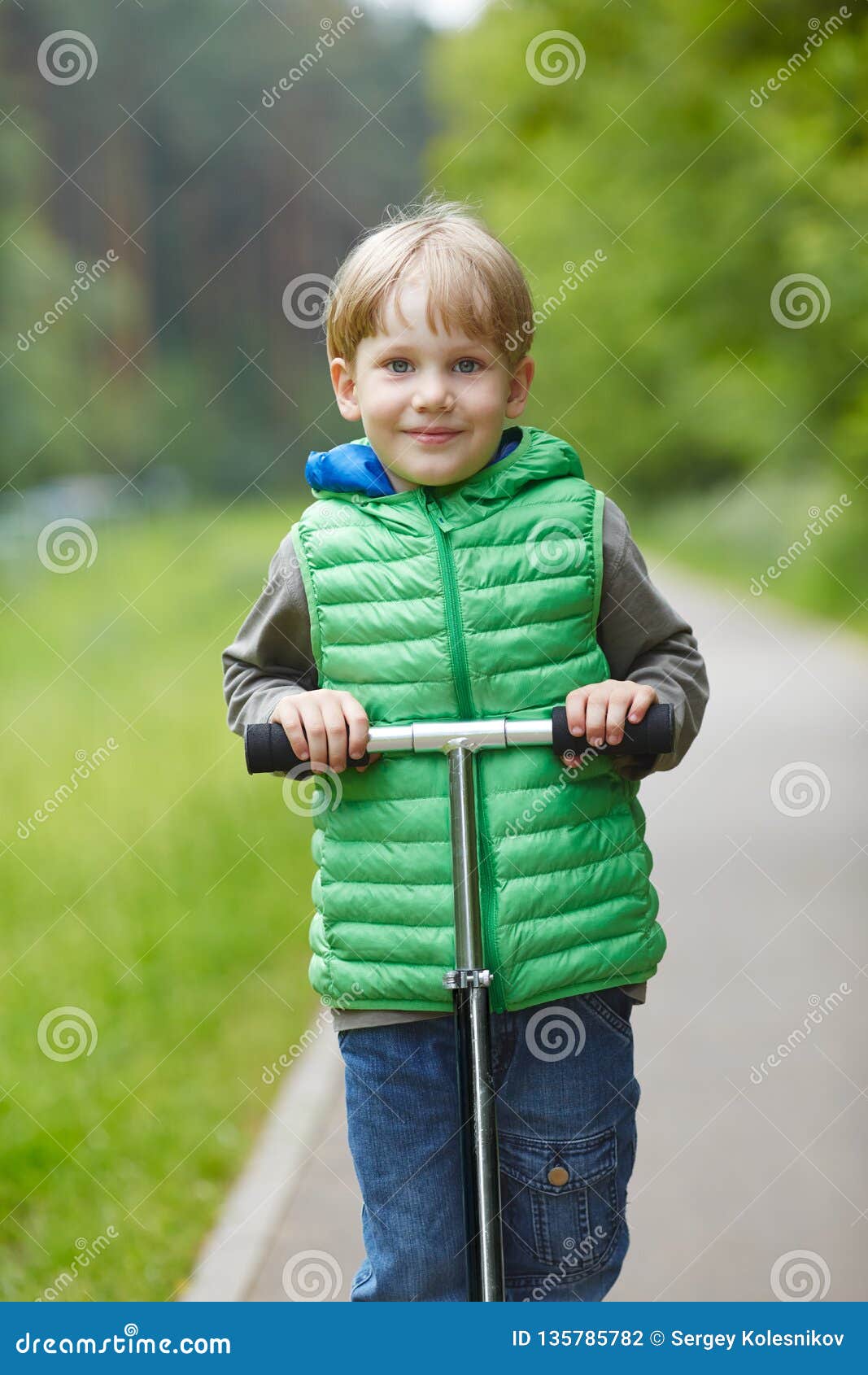 Little Boy Riding a Scooter in a Park Stock Photo - Image of happiness ... Little Boy Riding a Scooter in a Park Stock Photo - Image of happiness ...