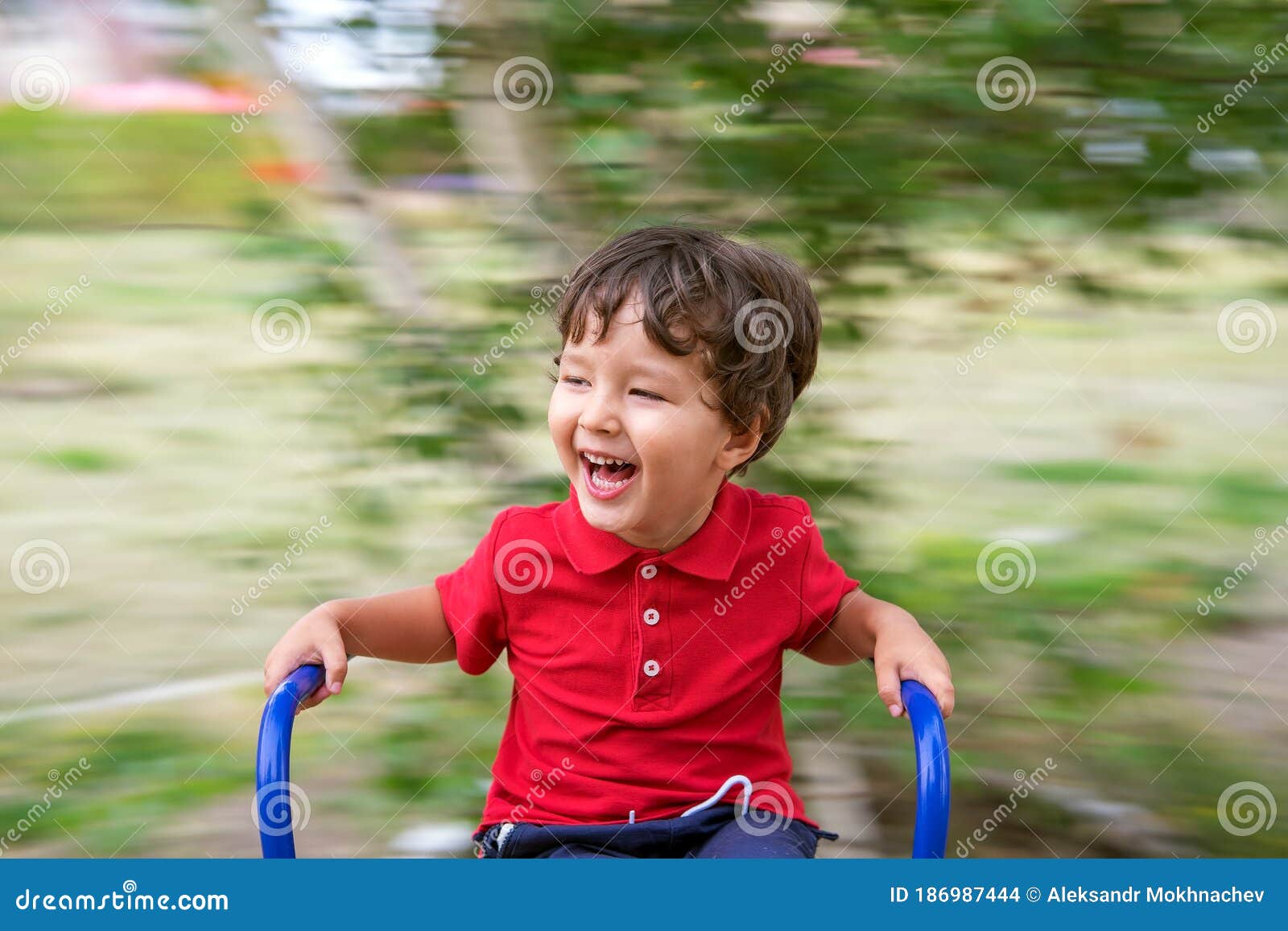Little boy riding a swing stock photo. Image of smiling - 186987444