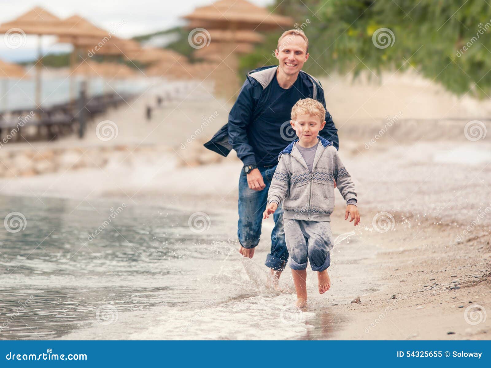 Little Boy Running with His Father at the Surf Line Stock Image - Image ...