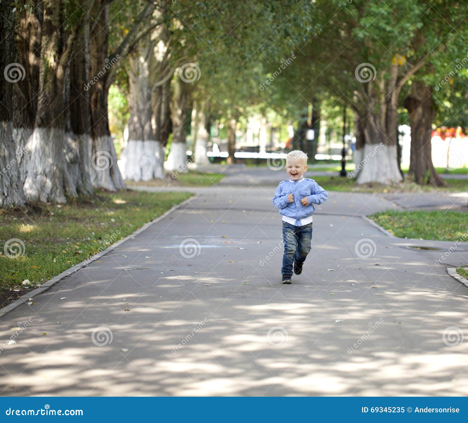 Little Boy Running on the Sidewalk in the Summer Park Stock Image ...