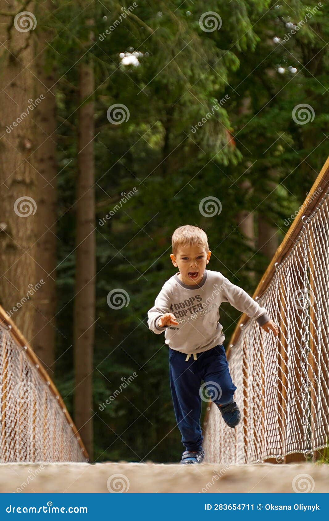A Little Boy Runs in Horror through the Forest. Stock Image - Image of ...