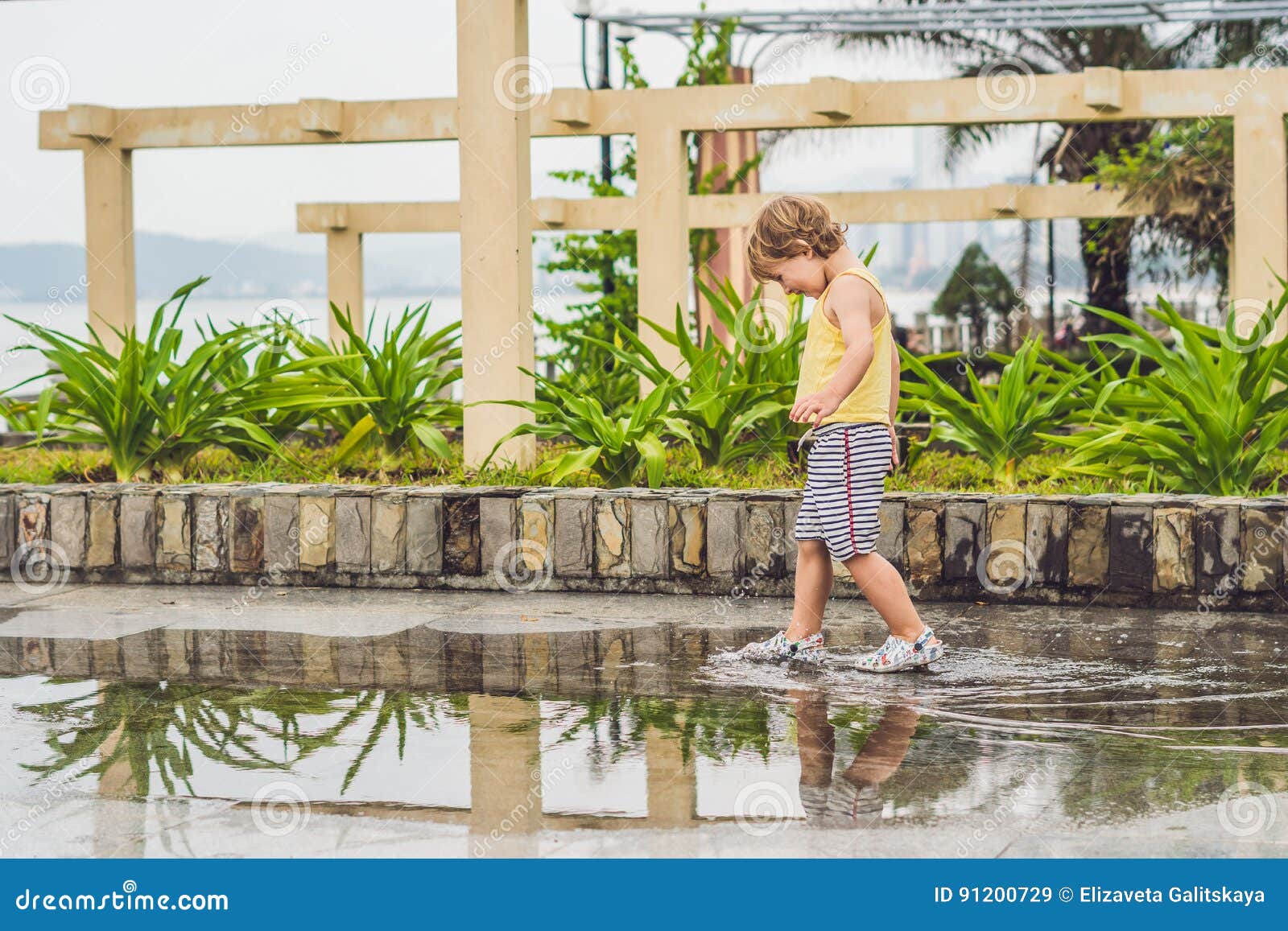Little Boy Runs through a Puddle. Summer Outdoor Stock Image - Image of ...