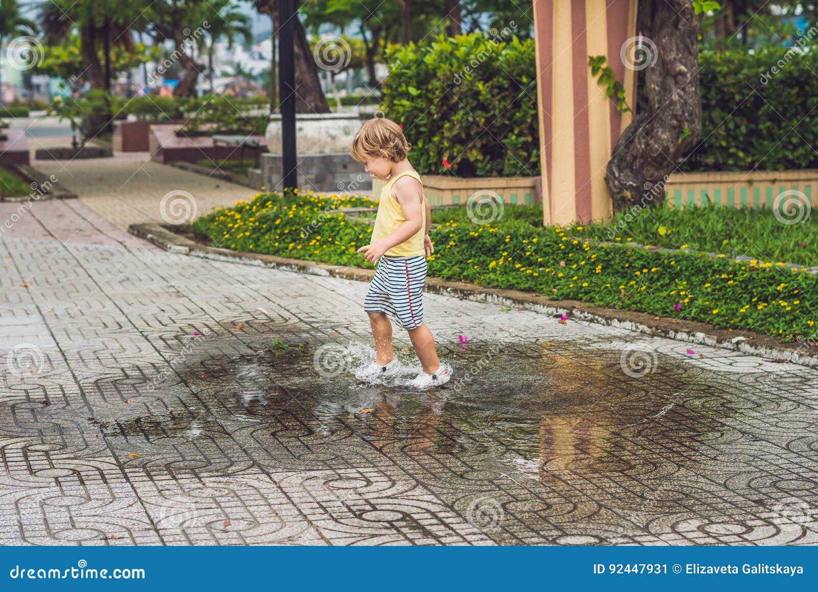 Little Boy Runs through a Puddle. Summer Outdoor Stock Image - Image of ...