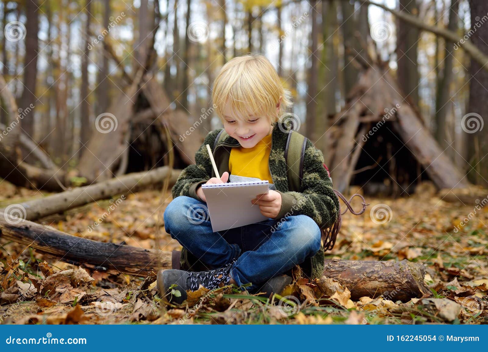 Little Boy Scout is Orienteering in Forest. Child is Sitting on Fallen ...