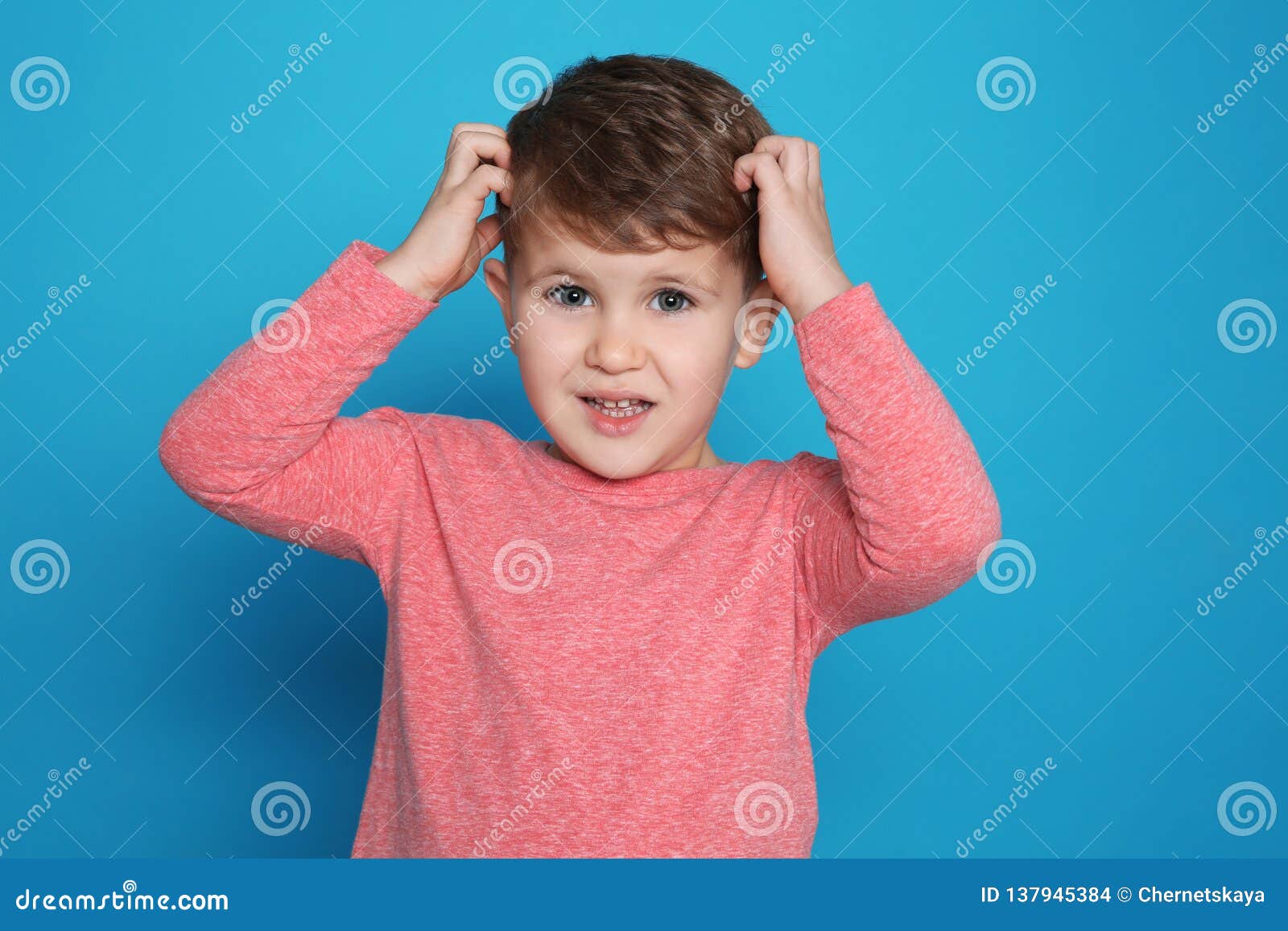 Little Boy Scratching Head on Color Background Stock Photo - Image of ...