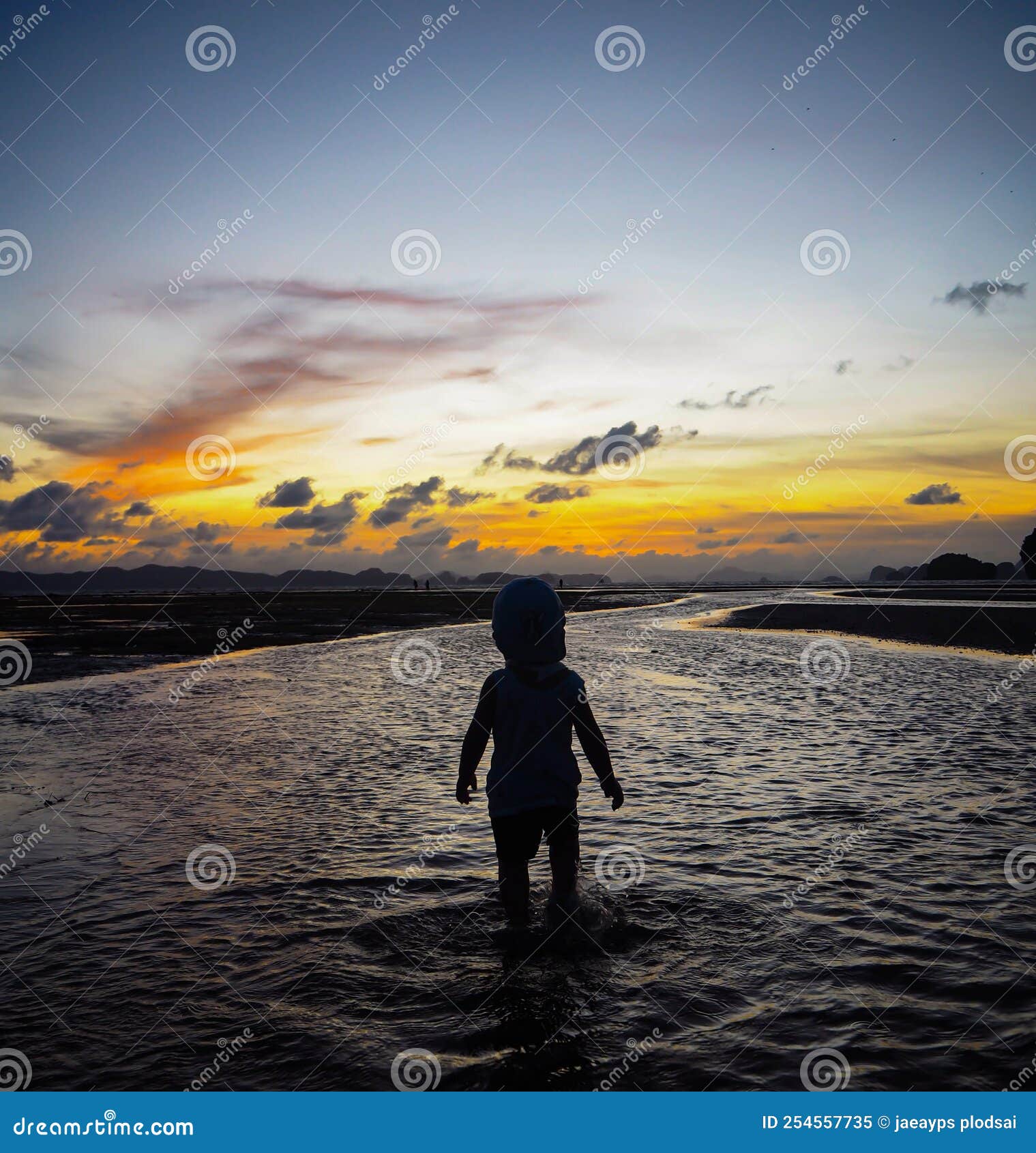 Little Boy in the Sea during the Orange Sunset. Stock Image - Image of ...