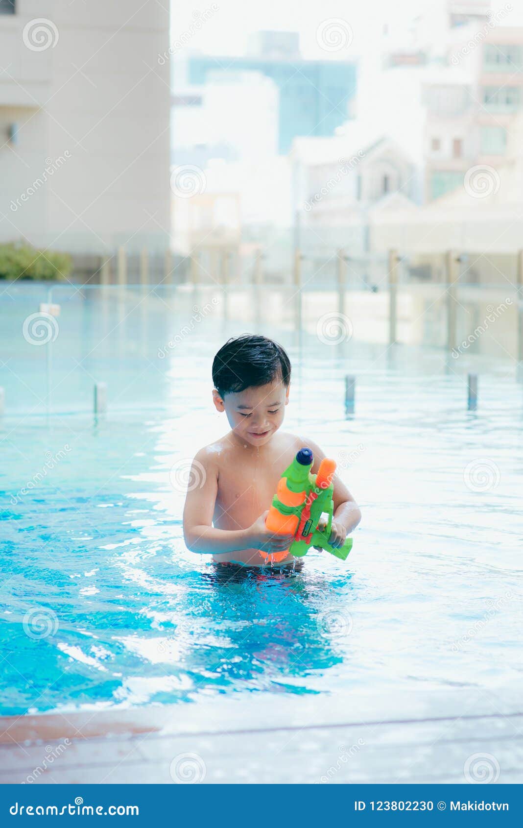Little Boy Shooting with Water Gun in the Pool Stock Photo - Image of ...