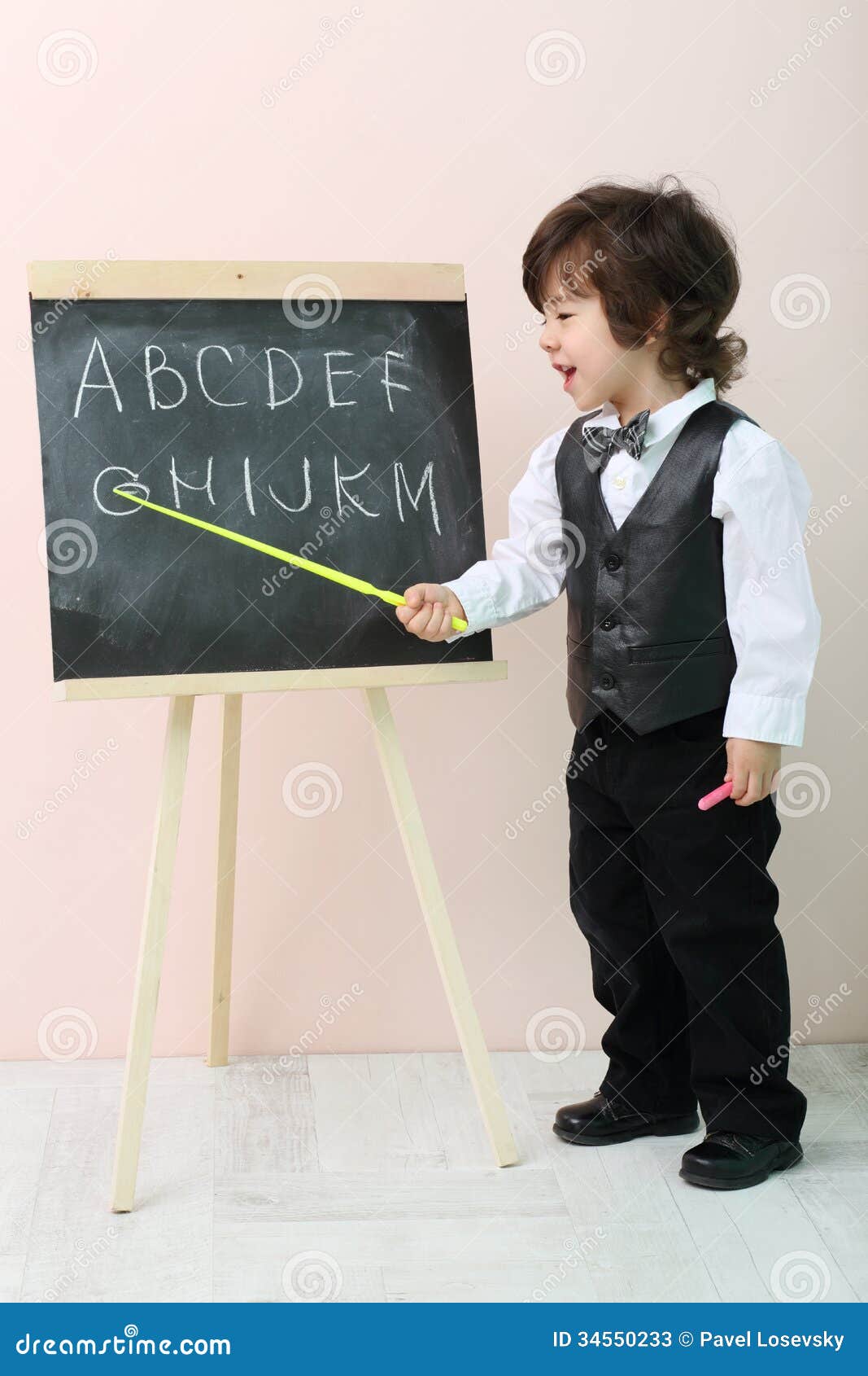 Little Boy Shows by Yellow Pointer Letters at Chalkboard Stock Image ...