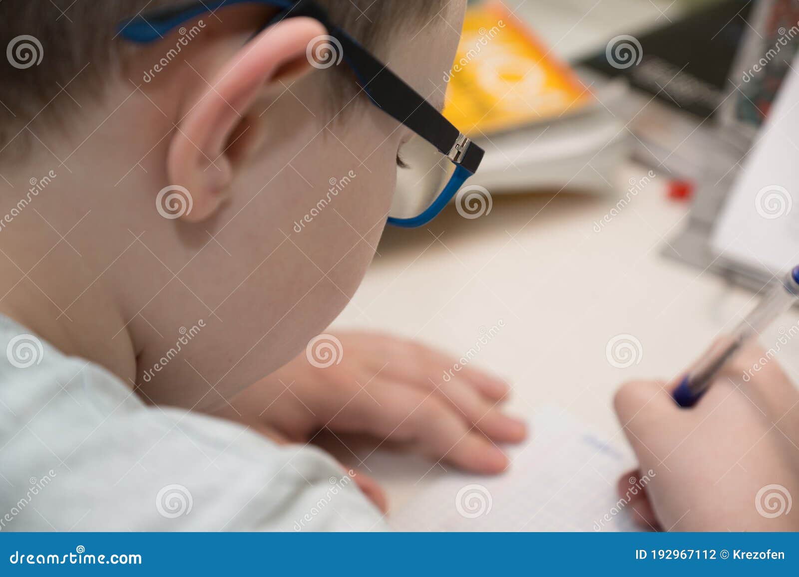 Little boy sits at a table stock photo. Image of read - 192967112