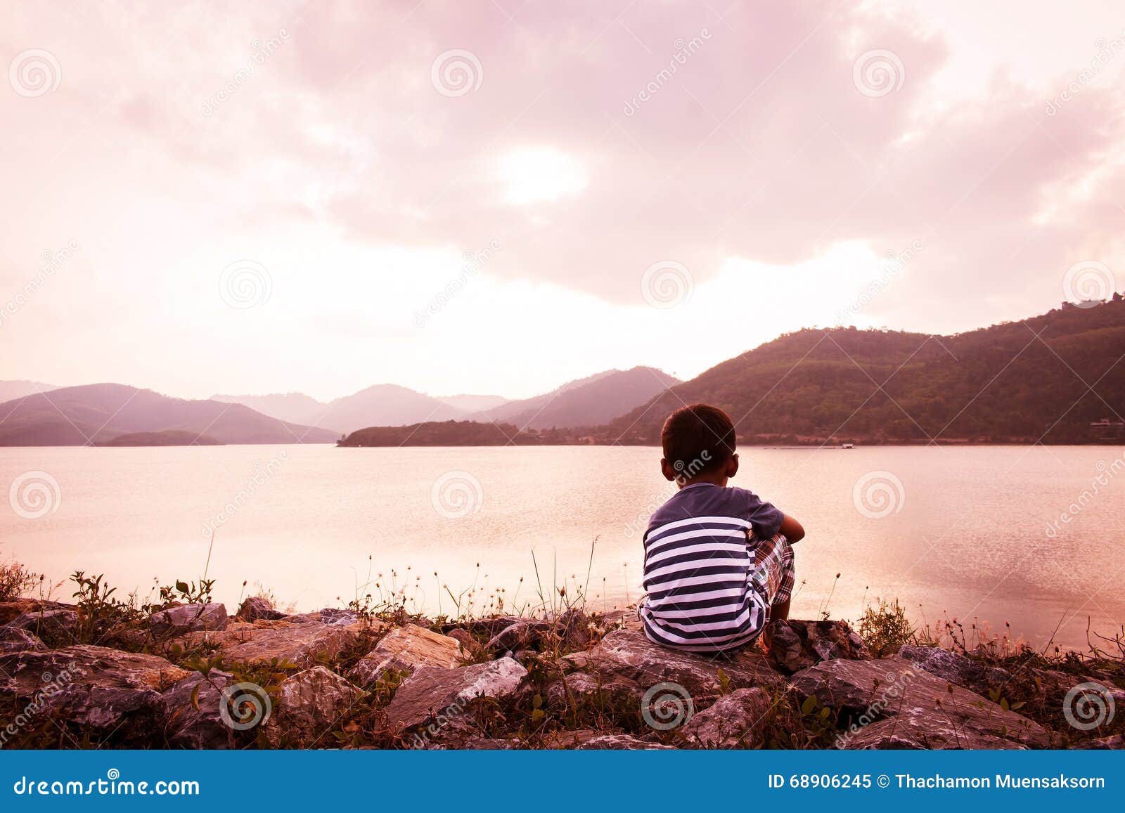 Little boy sitting alone stock image. Image of grass - 68906245