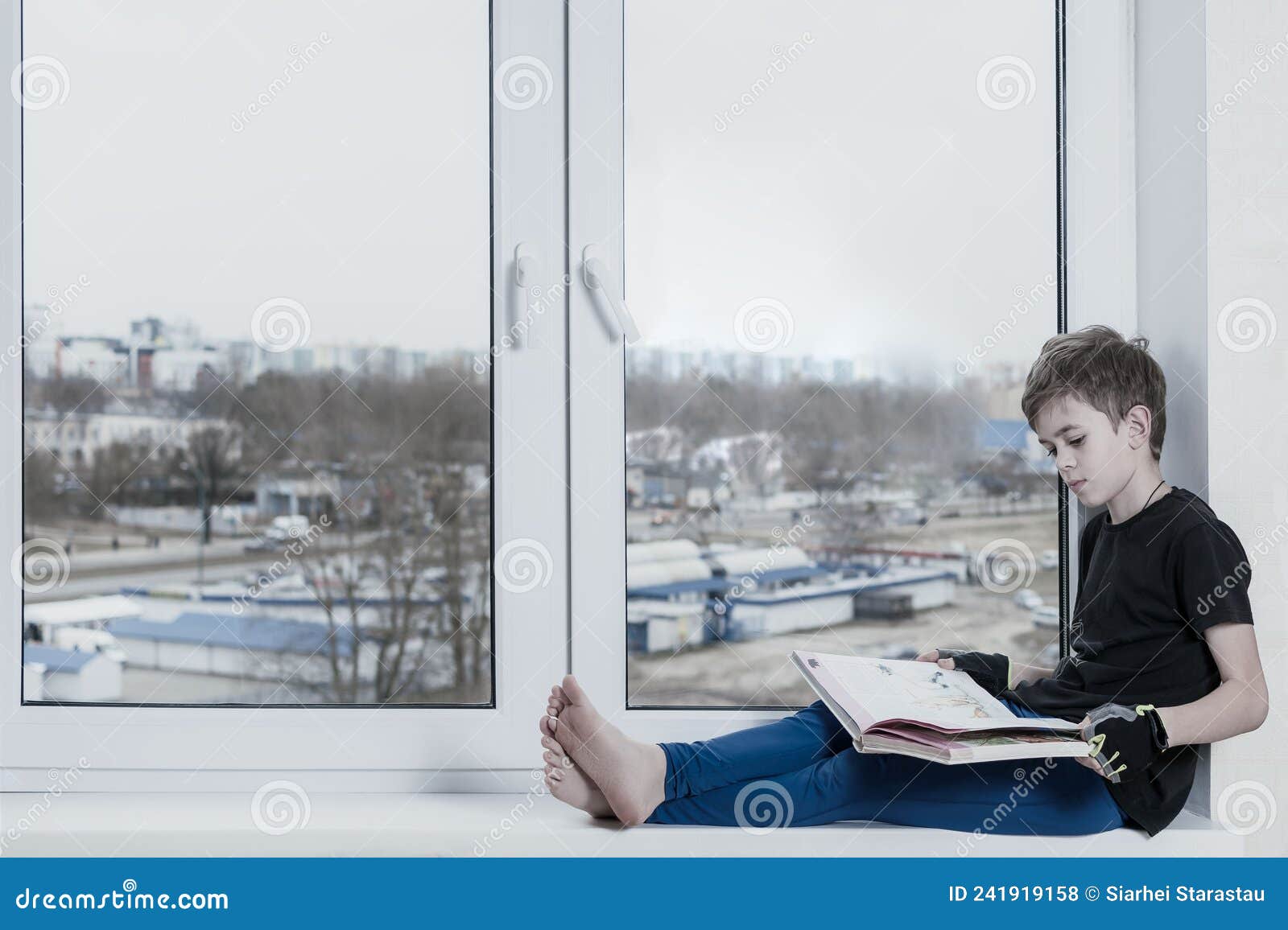 A Little Boy is Sitting Near the Window Stock Photo - Image of activity ...