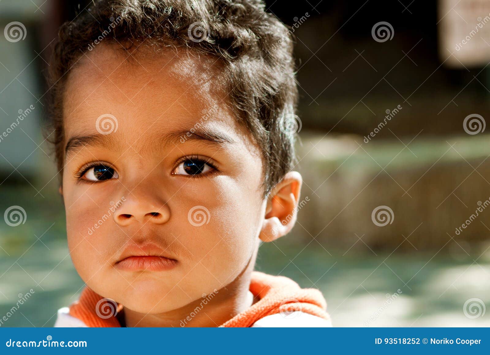 Little Boy Sitting Outside Looking at the Camera. Stock Photo - Image ...