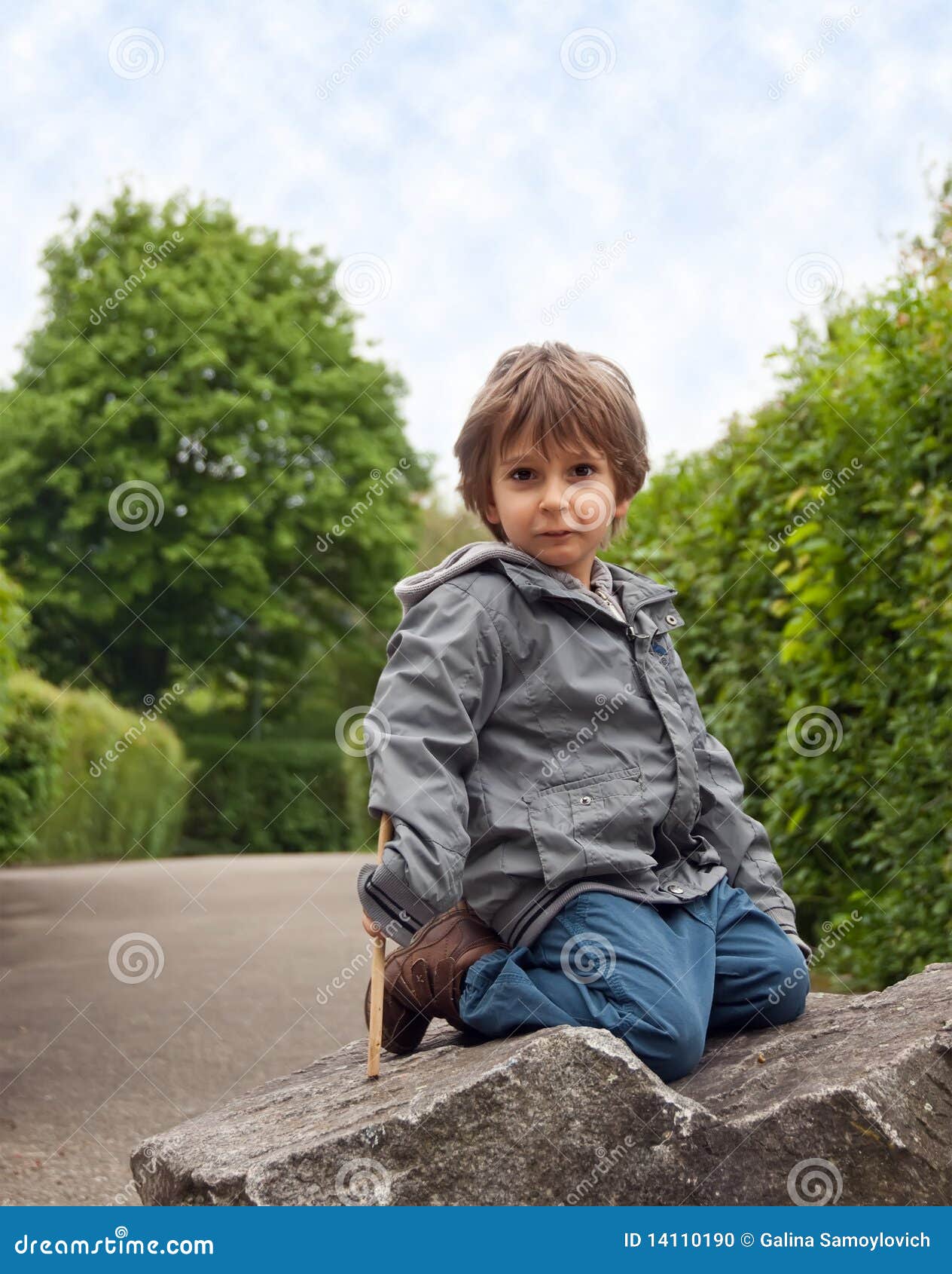 A Little Boy Sitting on a Rock. Stock Photo - Image of denim, portrait ...