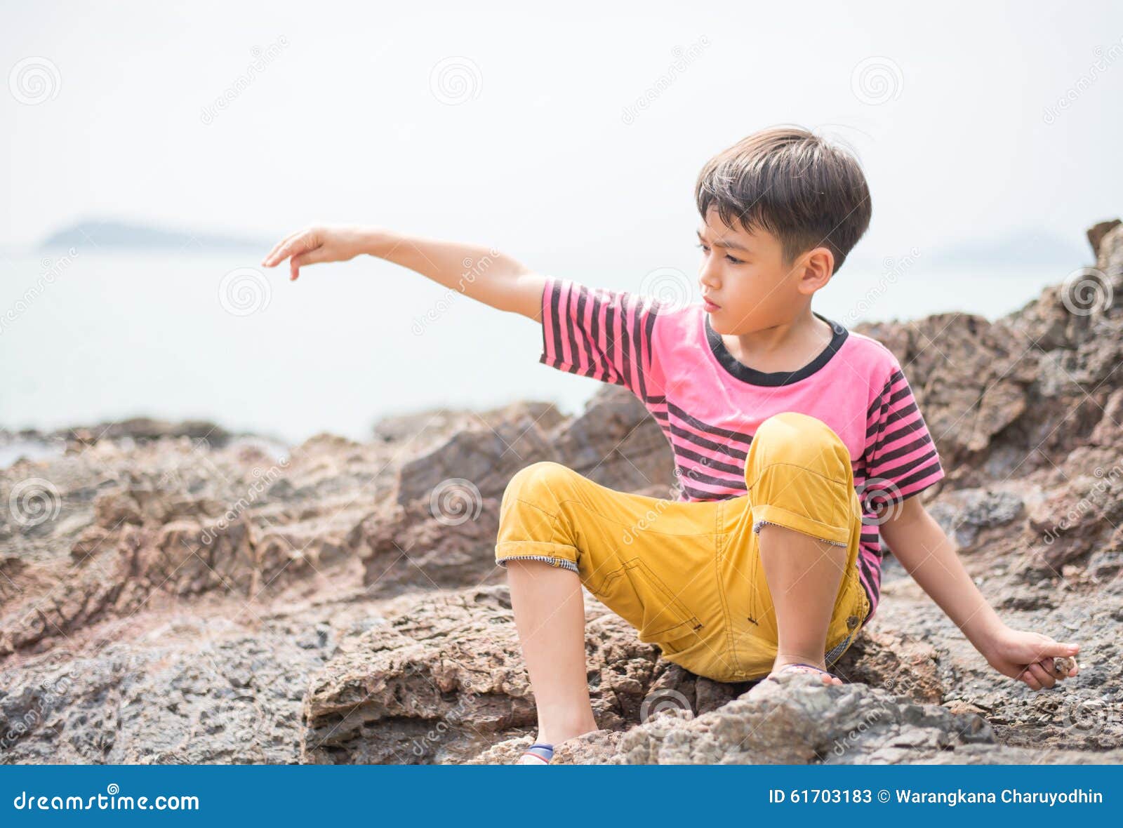 Little Boy Sitting on the Rock on the Beach Face Look Happy Stock Image ...