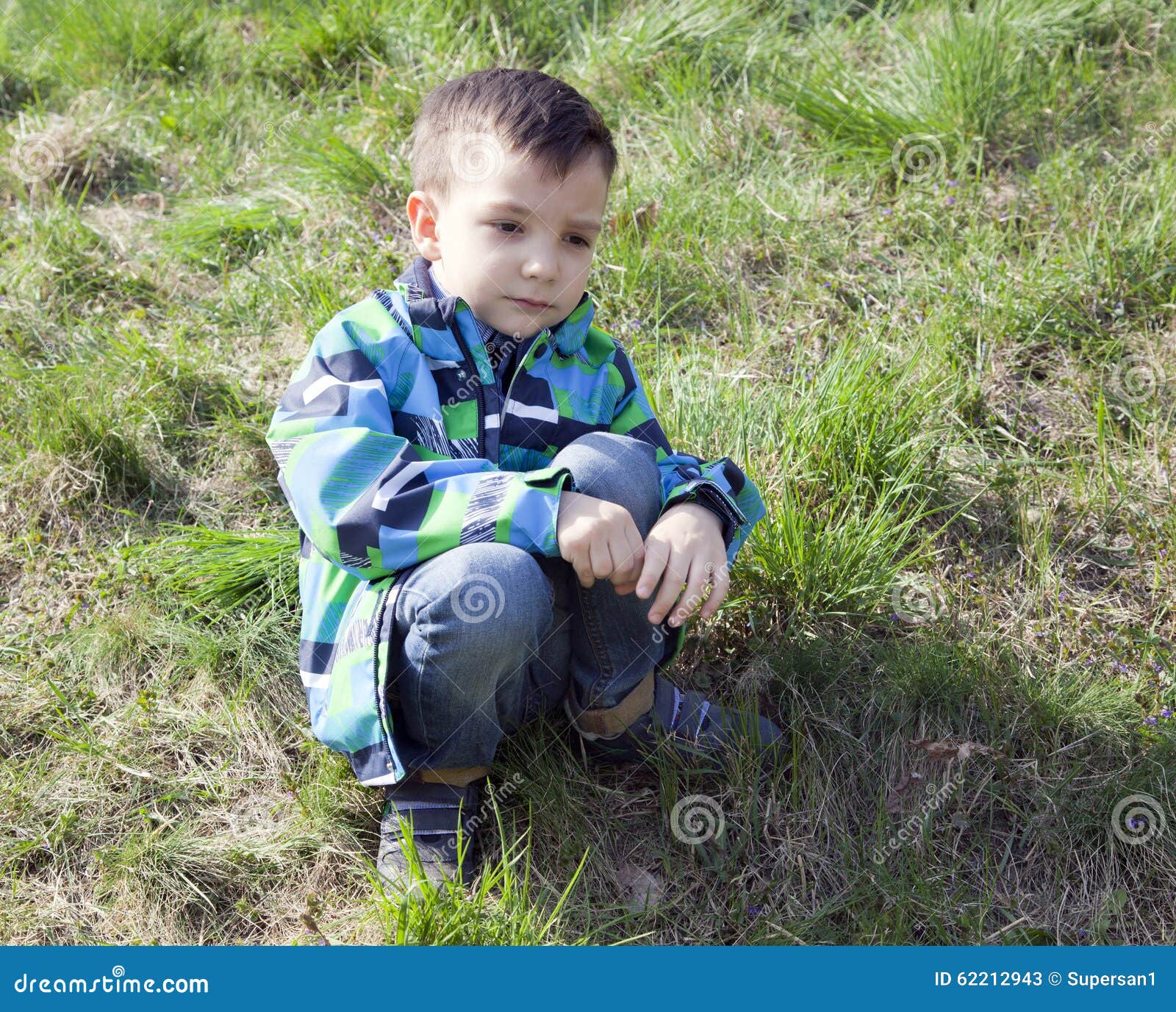 Little boy sitting and sad stock image. Image of green - 62212943