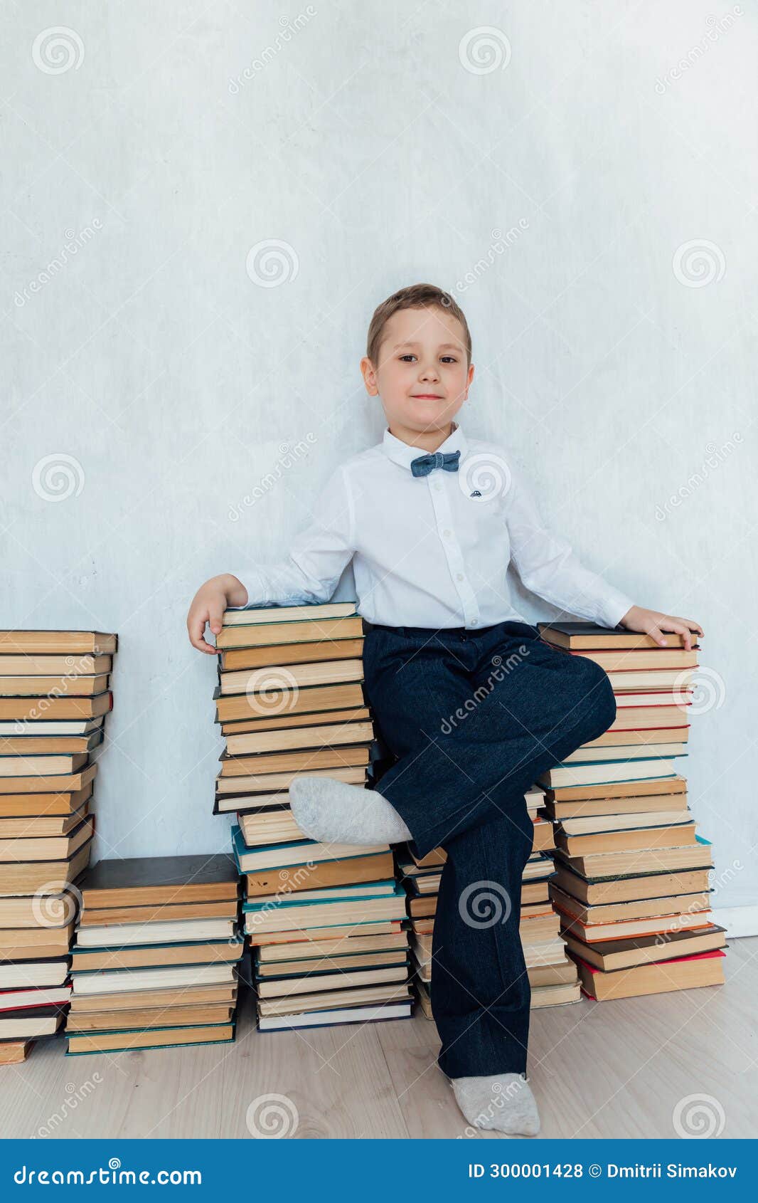 Little Boy Sitting on Stacks of Books in Library Stock Photo - Image of ...