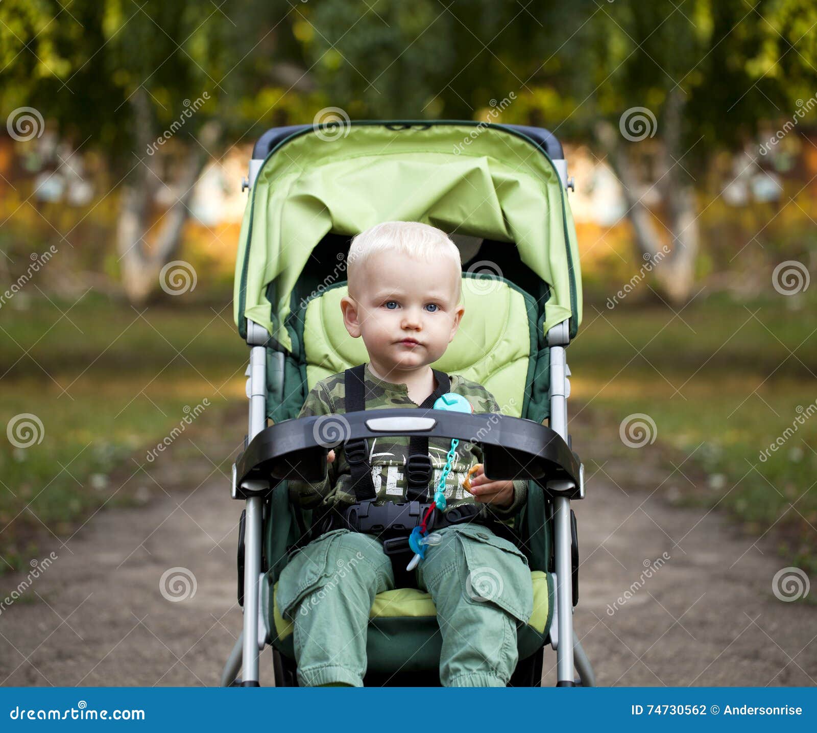 Little Boy Sitting in Stroller Stock Photo - Image of park, blonde ...