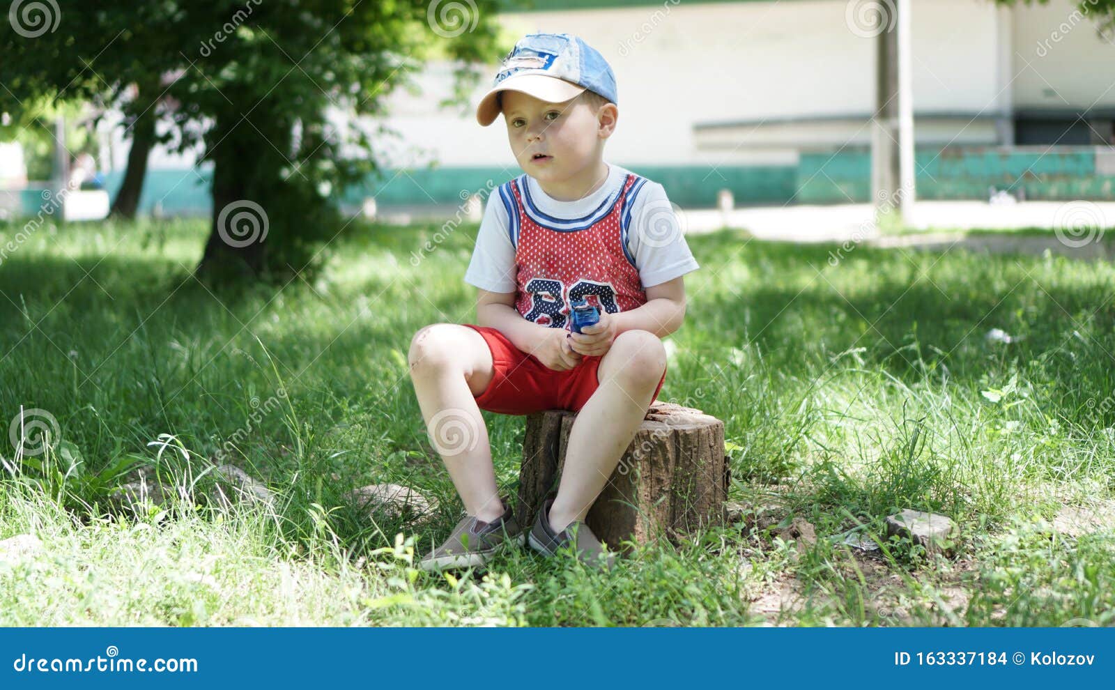 Little Boy Sitting on the Stump in Playground Stock Photo - Image of ...