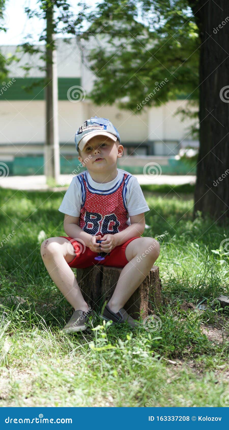Little Boy Sitting on the Stump in Playground Stock Photo - Image of ...