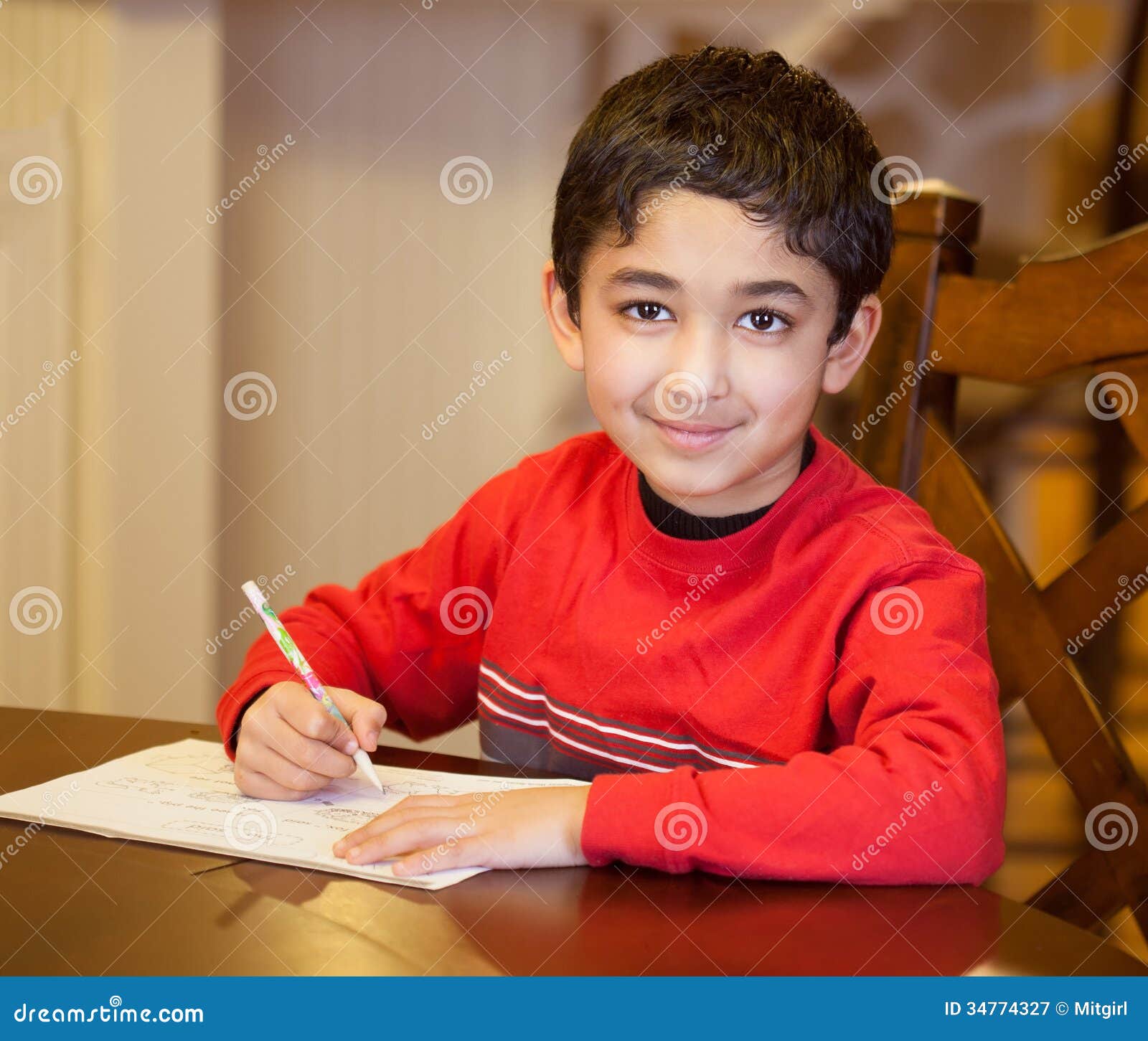 Little Boy Sitting at a Table and Doing His Homework Stock Image ...