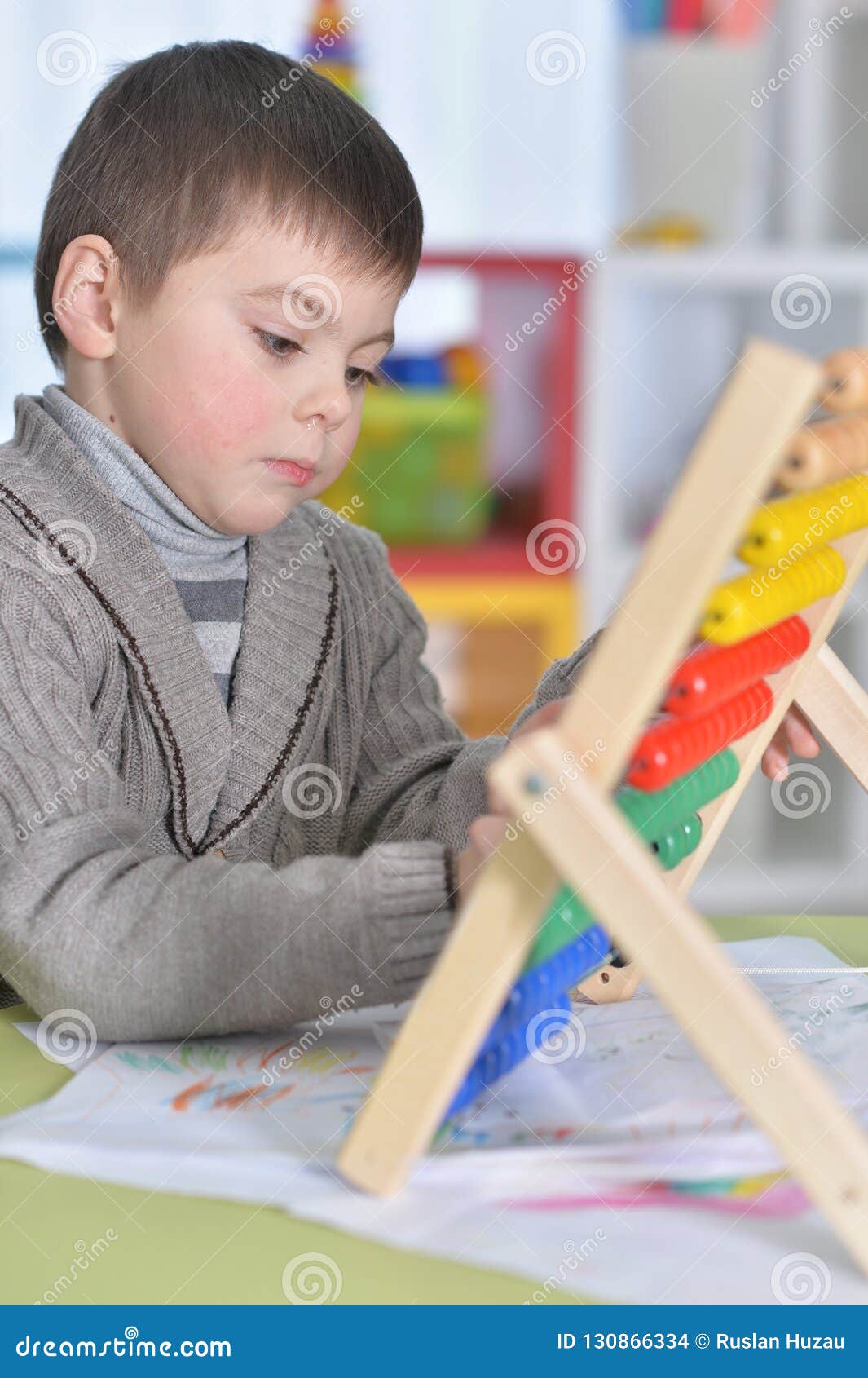 Portrait of a Boy Sitting at Table and Learning To Use Abacus Stock ...