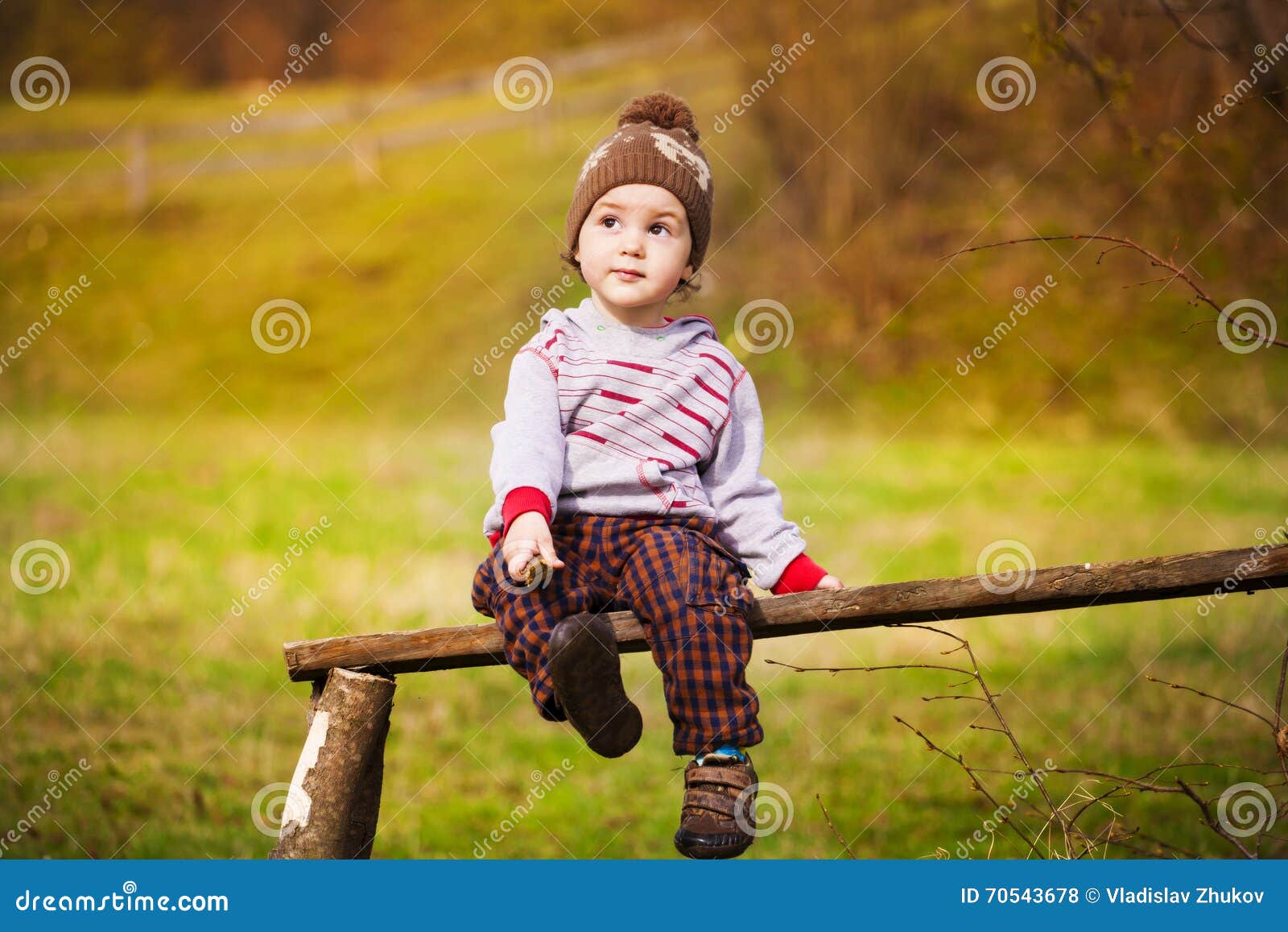 A Little Boy is Sitting Under a Tree. Stock Photo - Image of infant ...