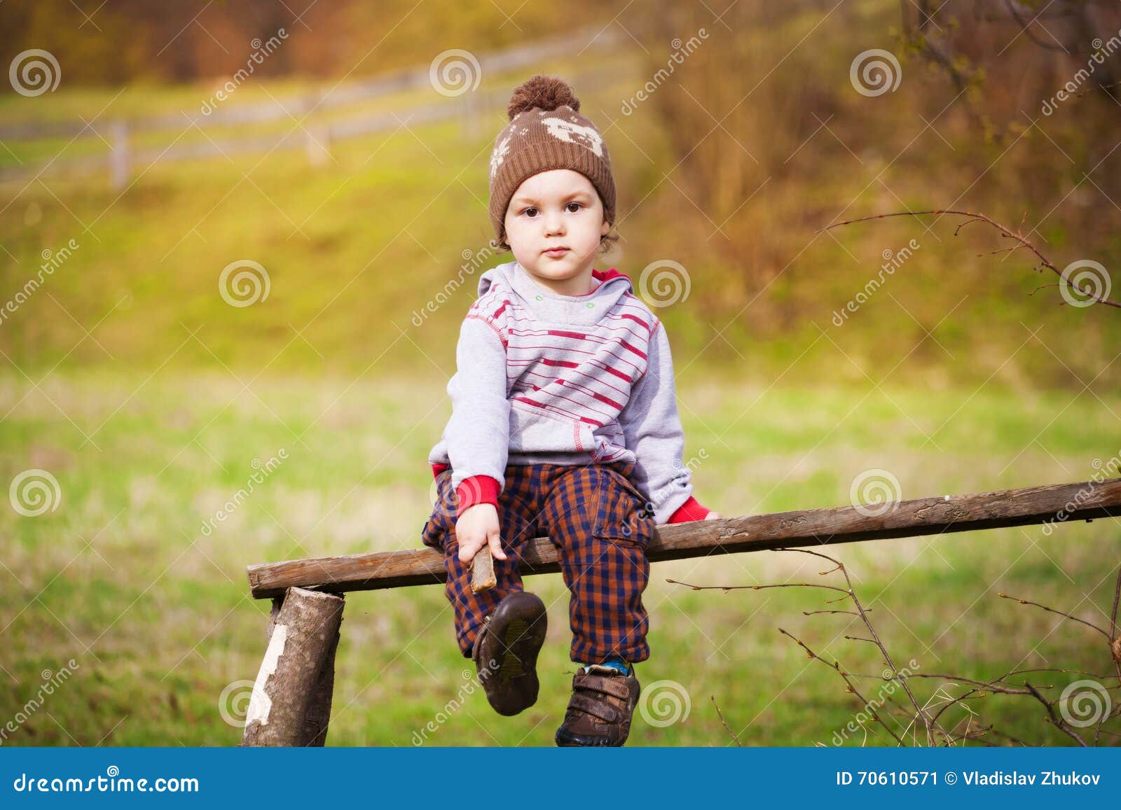 A Little Boy is Sitting Under a Tree. Stock Image - Image of childhood ...
