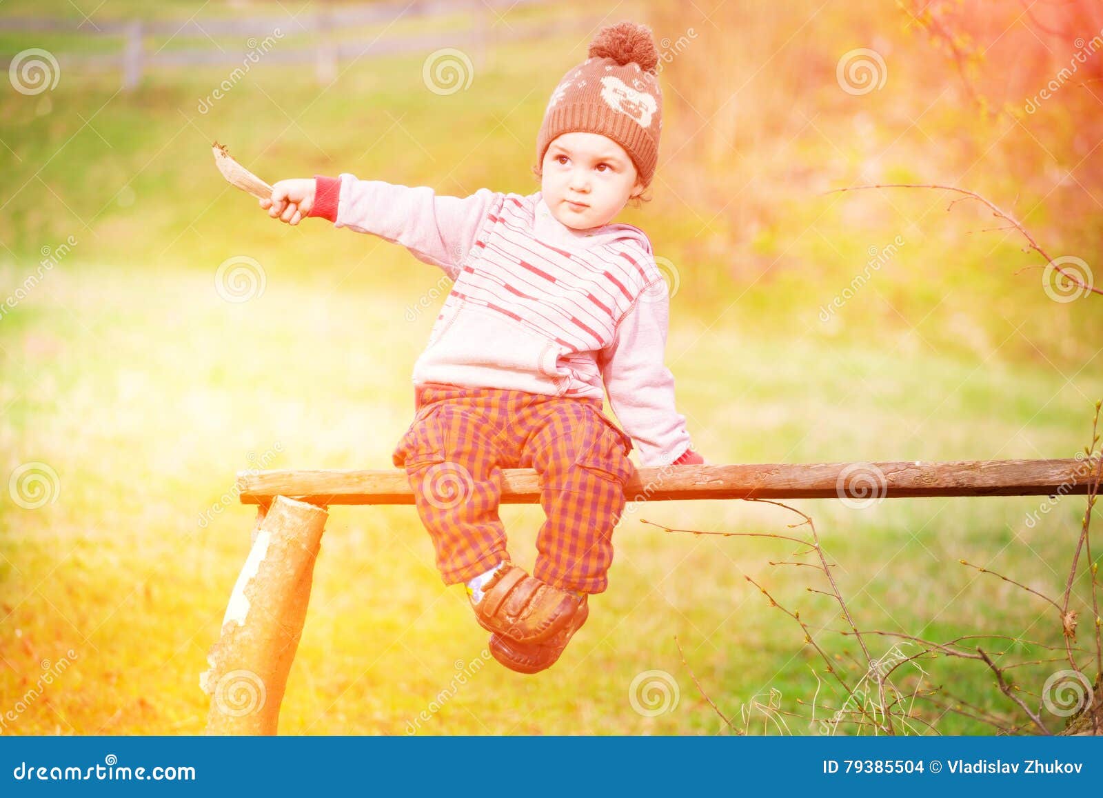 A Little Boy is Sitting Under a Tree. Stock Photo - Image of background ...