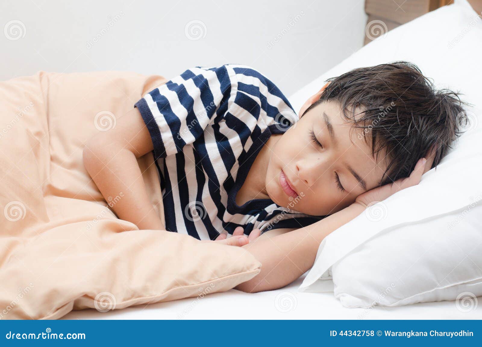 Little boy sleeping on bed stock photo. Image of pillow - 44342758