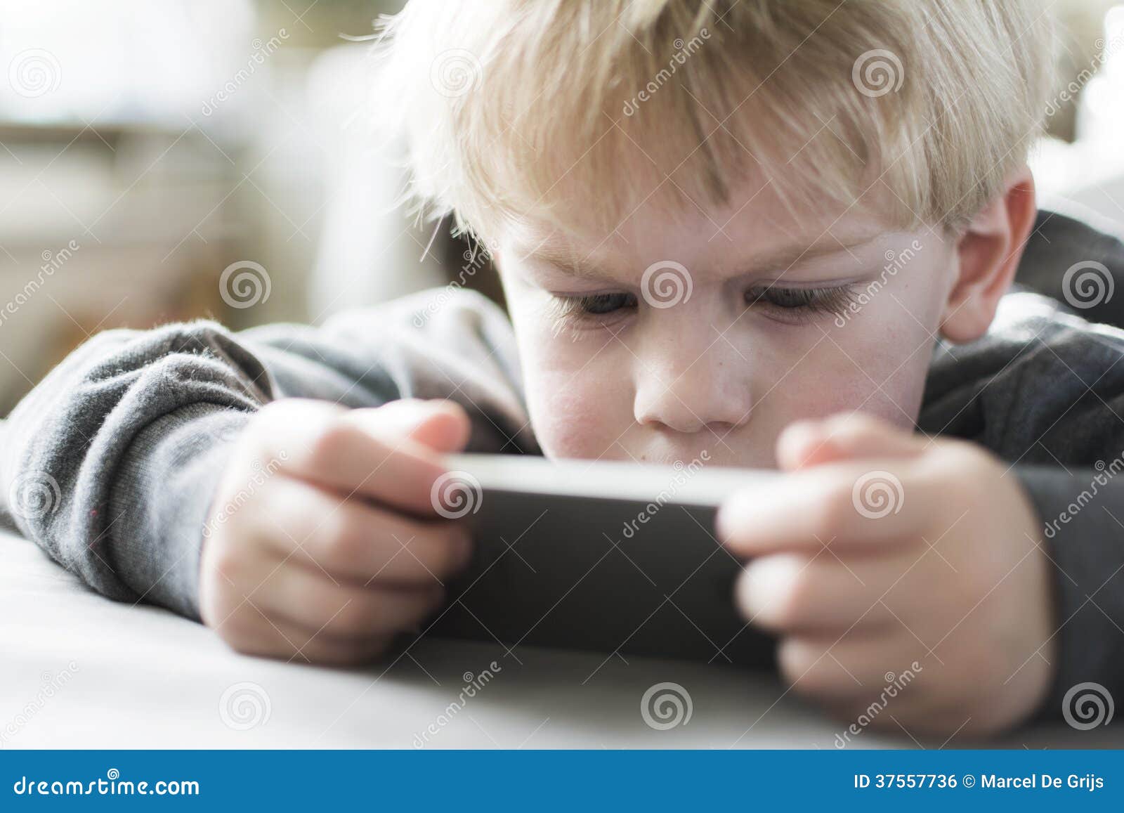 Little boy on smartphone stock photo. Image of close - 37557736
