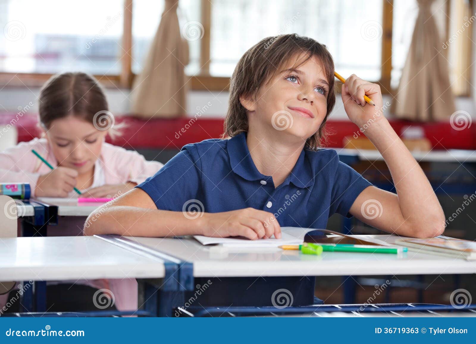 Little Boy Smiling while Looking Up in Classroom Stock Image - Image of ...