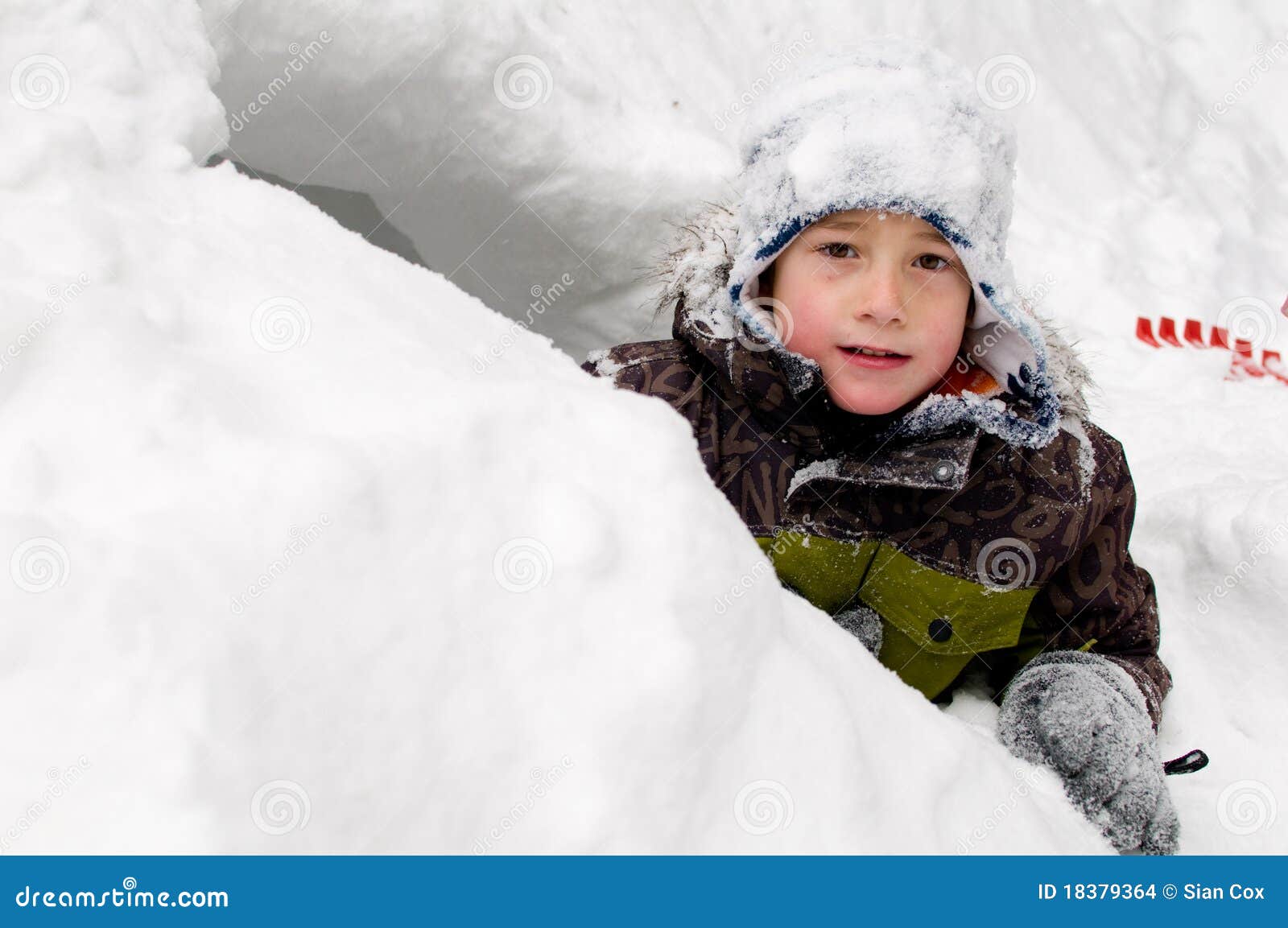 Little boy in a snow fort stock photo. Image of playing - 18379364