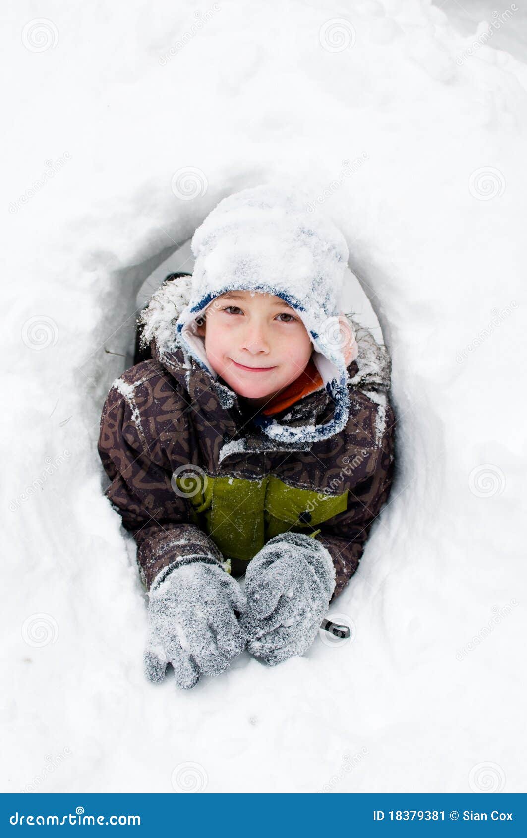 Little boy in a snow fort stock image. Image of childhood - 18379381