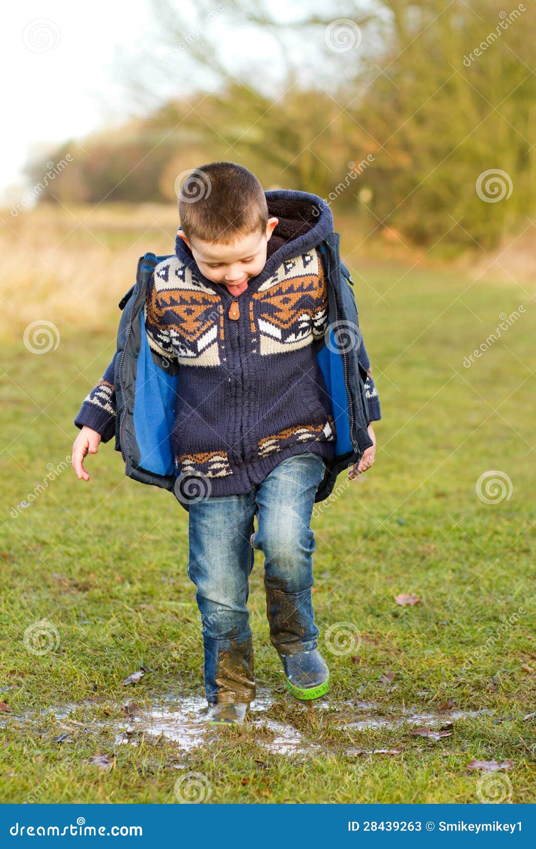 Little Boy Splashing in a Puddle in the Field Stock Image - Image of ...
