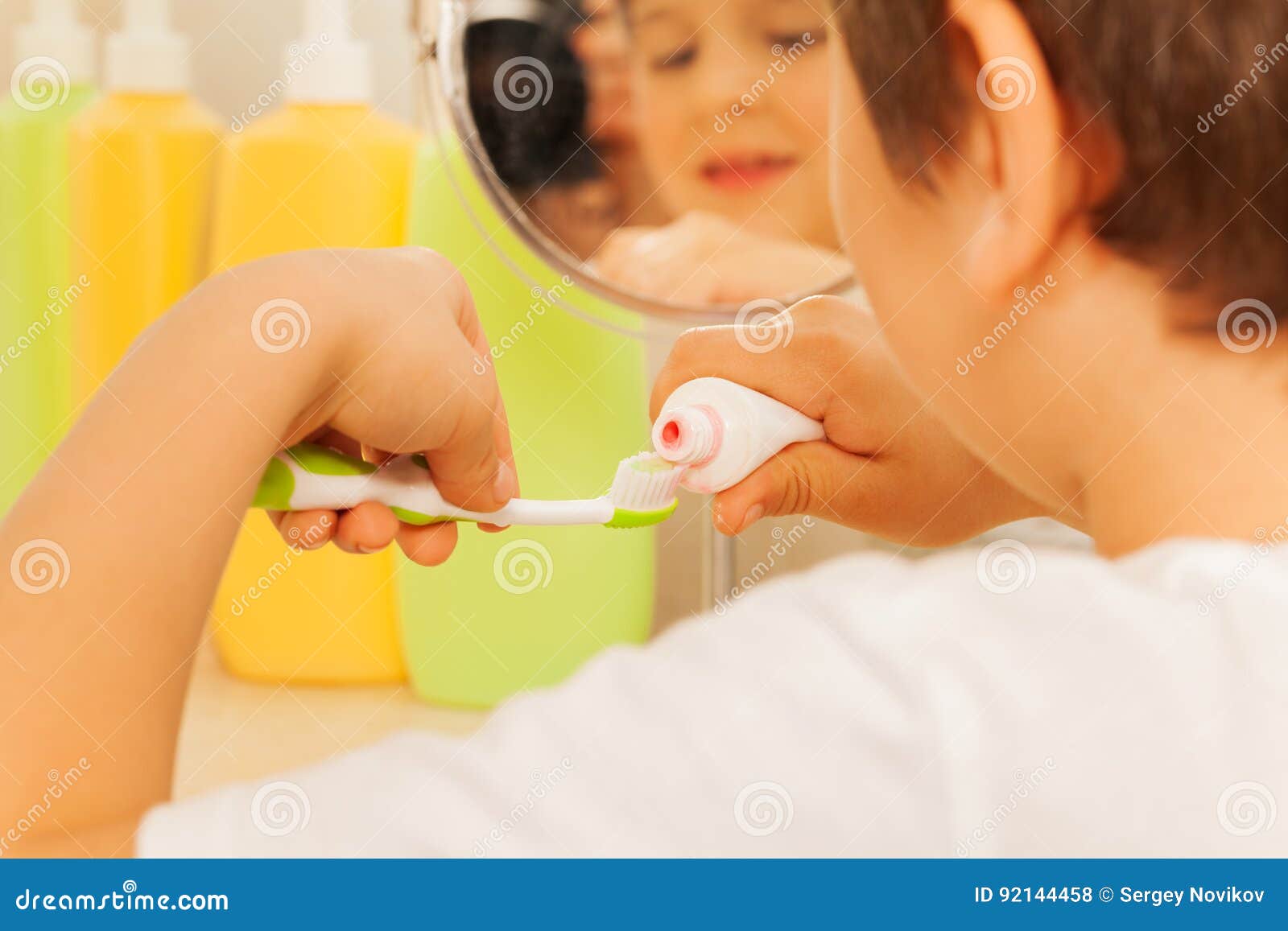 Little Boy Spreading Toothpaste on a Toothbrush Stock Photo - Image of ...