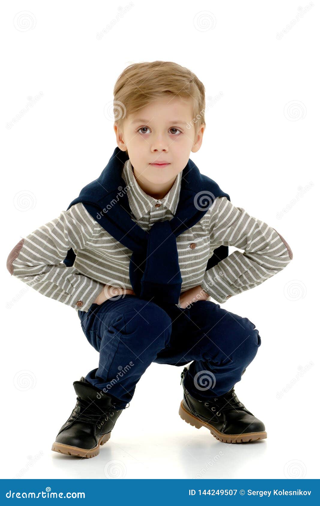 The Little Boy is Squatting. Stock Image - Image of cheerful, sand ...