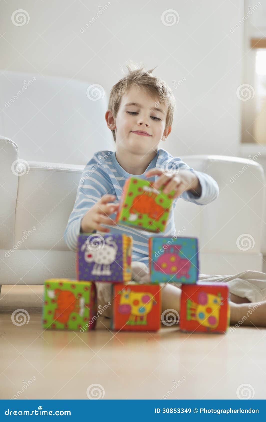 Little Boy Stacking Blocks while Sitting on Floor Stock Image - Image ...