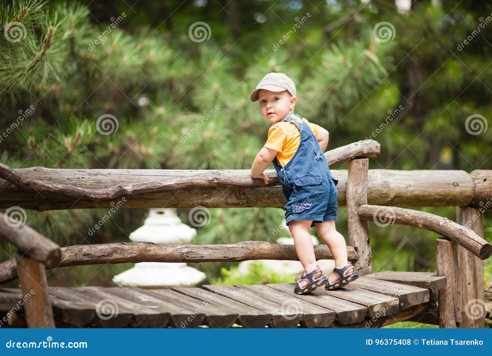 Little Boy is Standing on the Bench Outside Stock Photo - Image of ...
