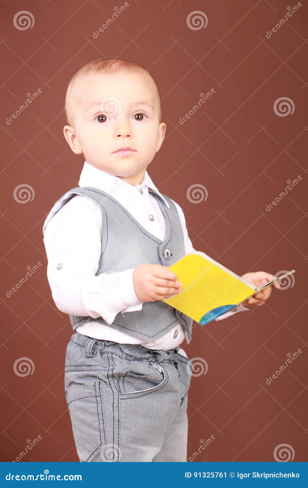 Little Boy Standing and Holding a Book in His Hands Stock Image - Image ...