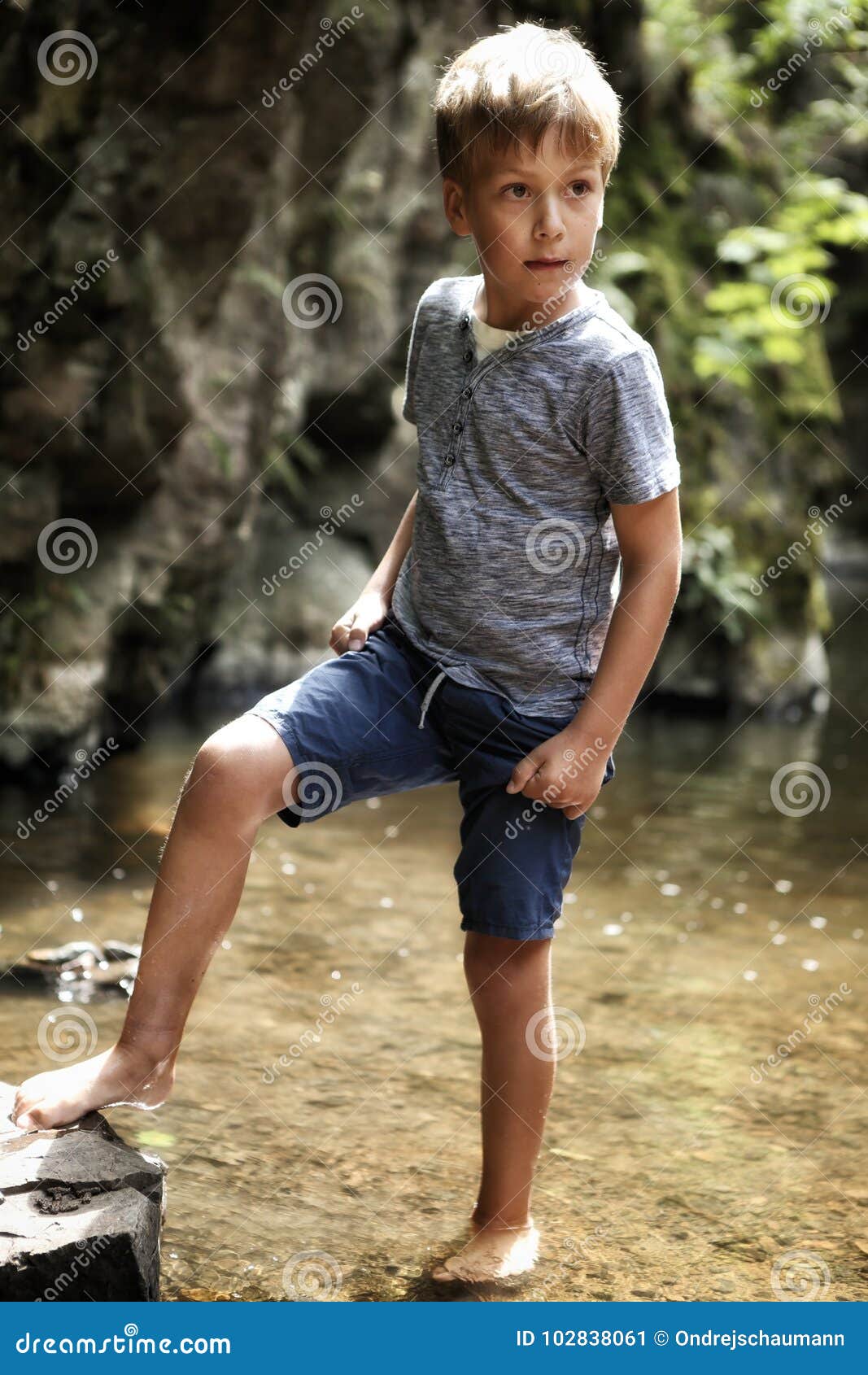 Little Boy Standing on the Rock in the River Stock Image - Image of ...