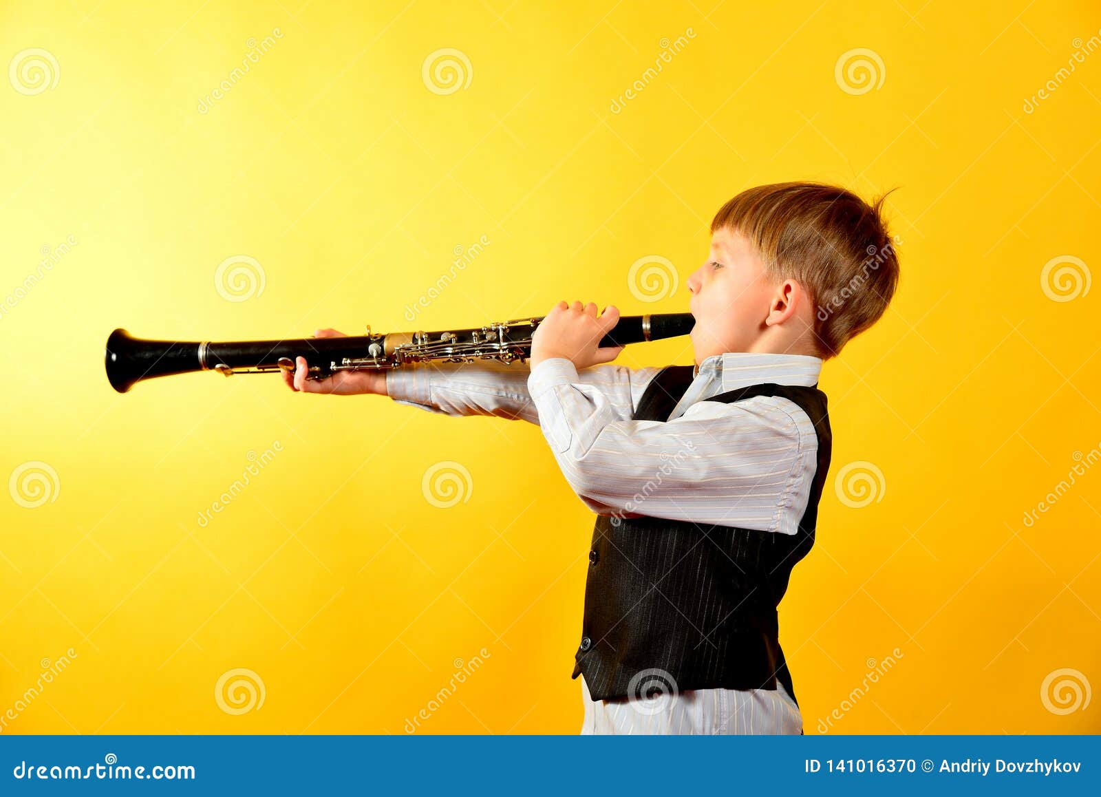 A Little Boy in a Suit Plays the Clarinet Stock Photo - Image of ...