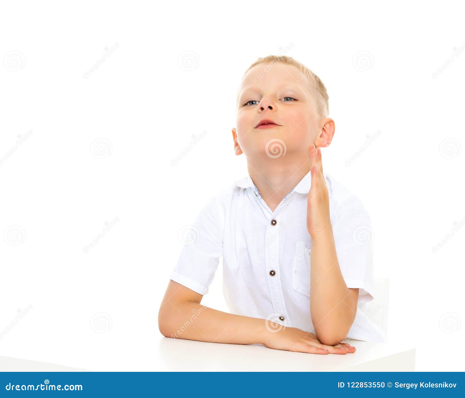 A Little Boy at the Table in the School Does His Homework. Stock Photo ...
