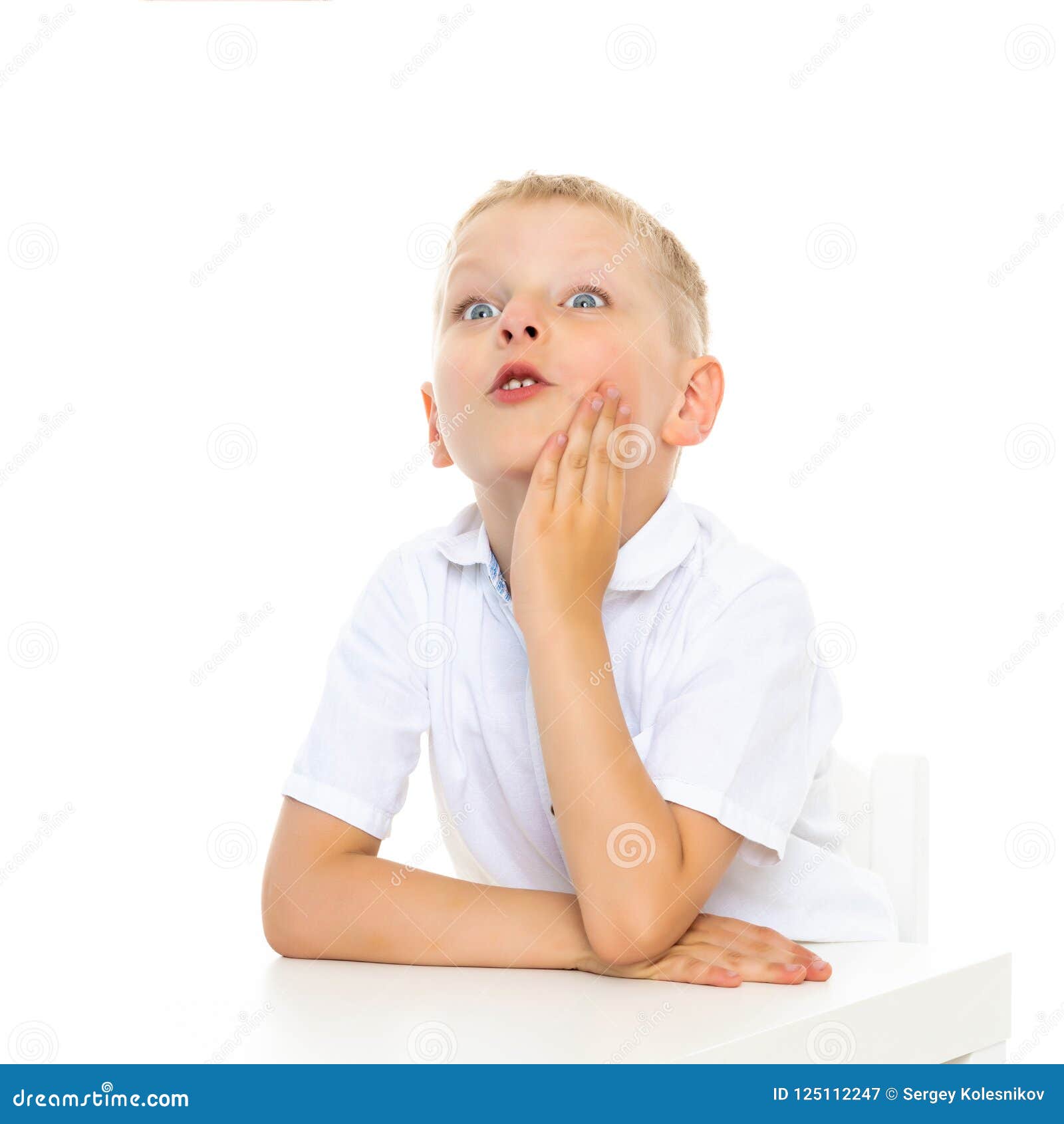 A Little Boy at the Table in the School Does His Homework. Stock Image ...
